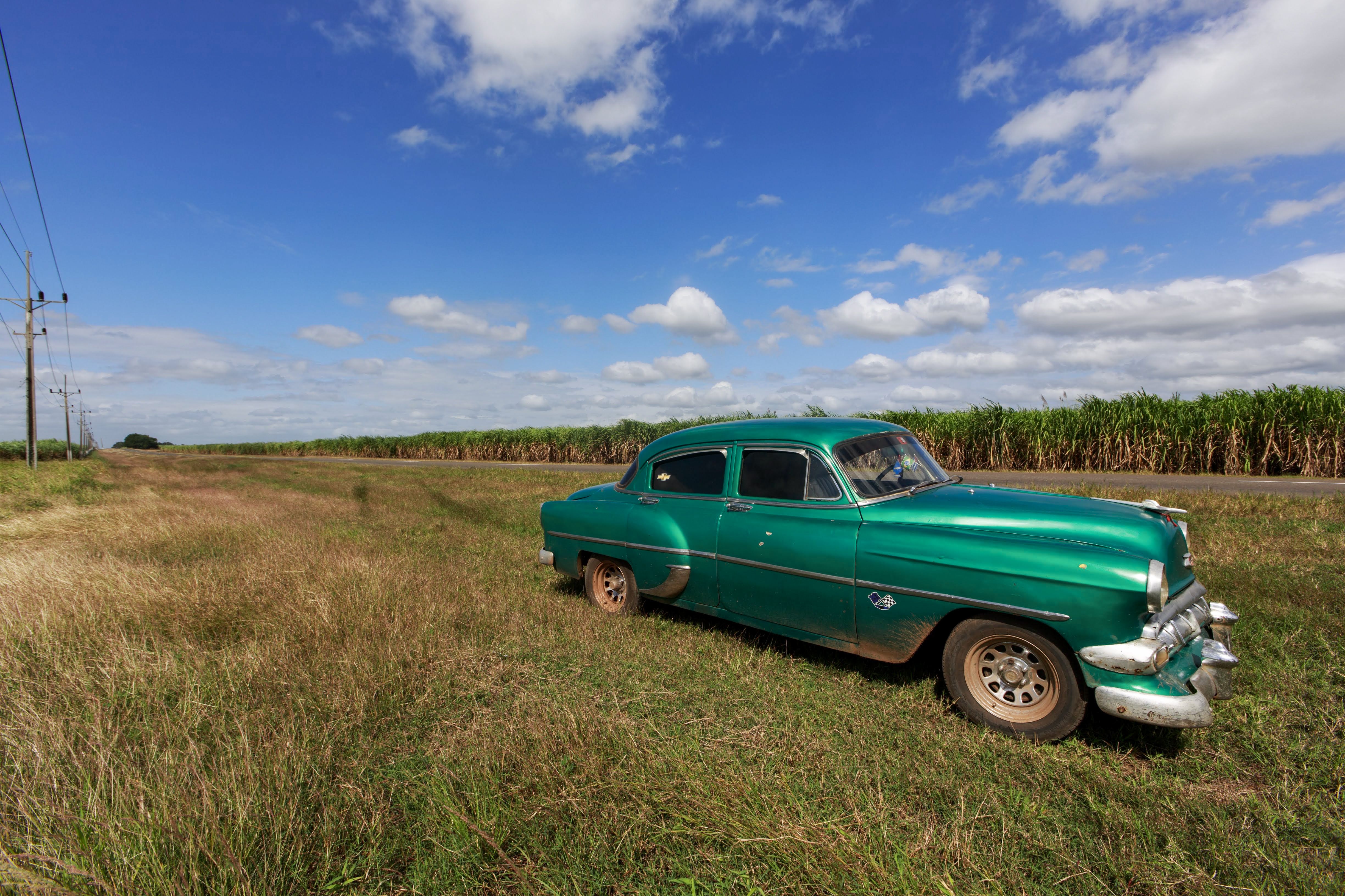 Green Car on Green Grass Field Under Blue Sky · Free Stock Photo