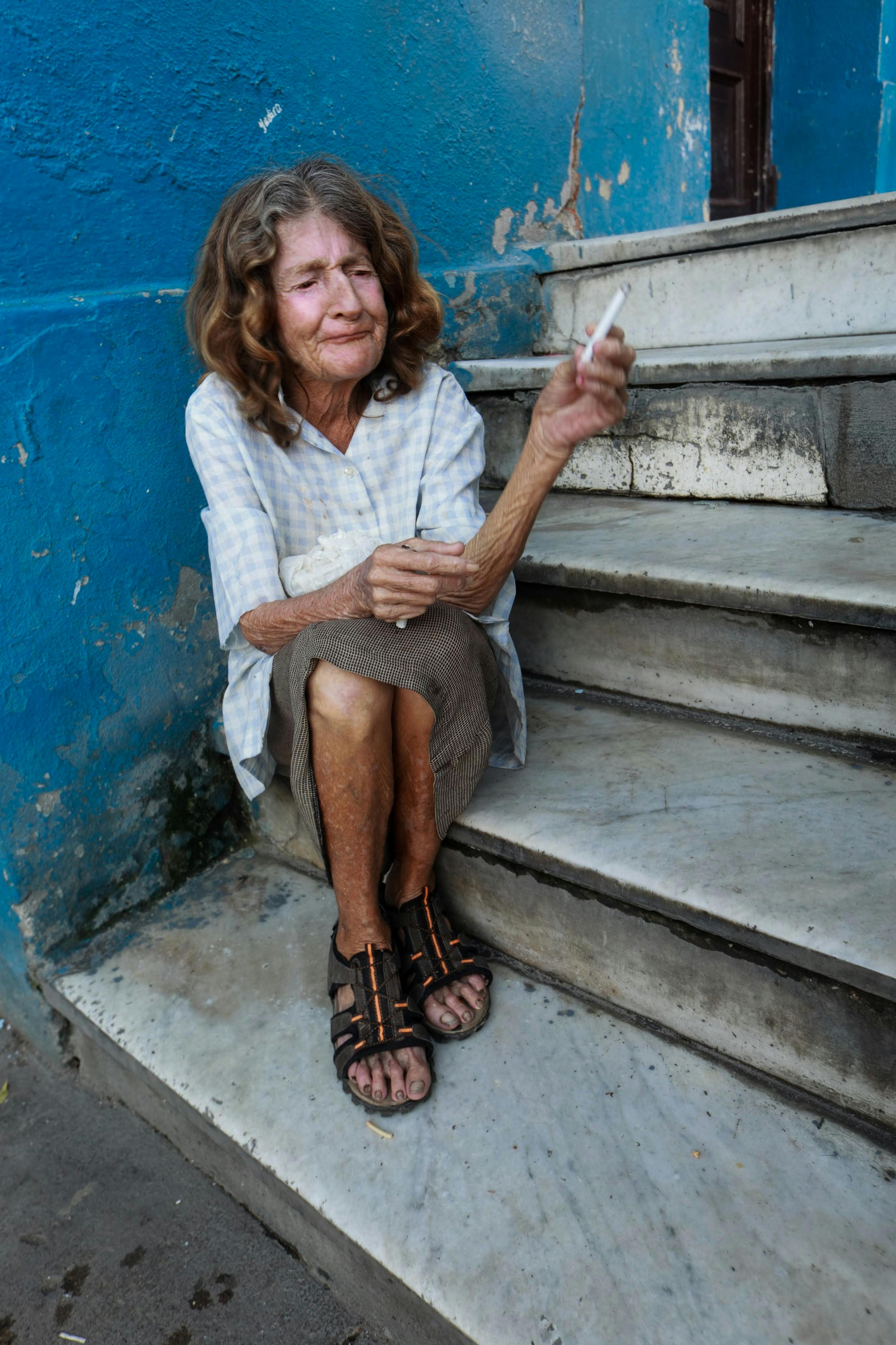 Smoking Woman Sitting on Steps · Free Stock Photo