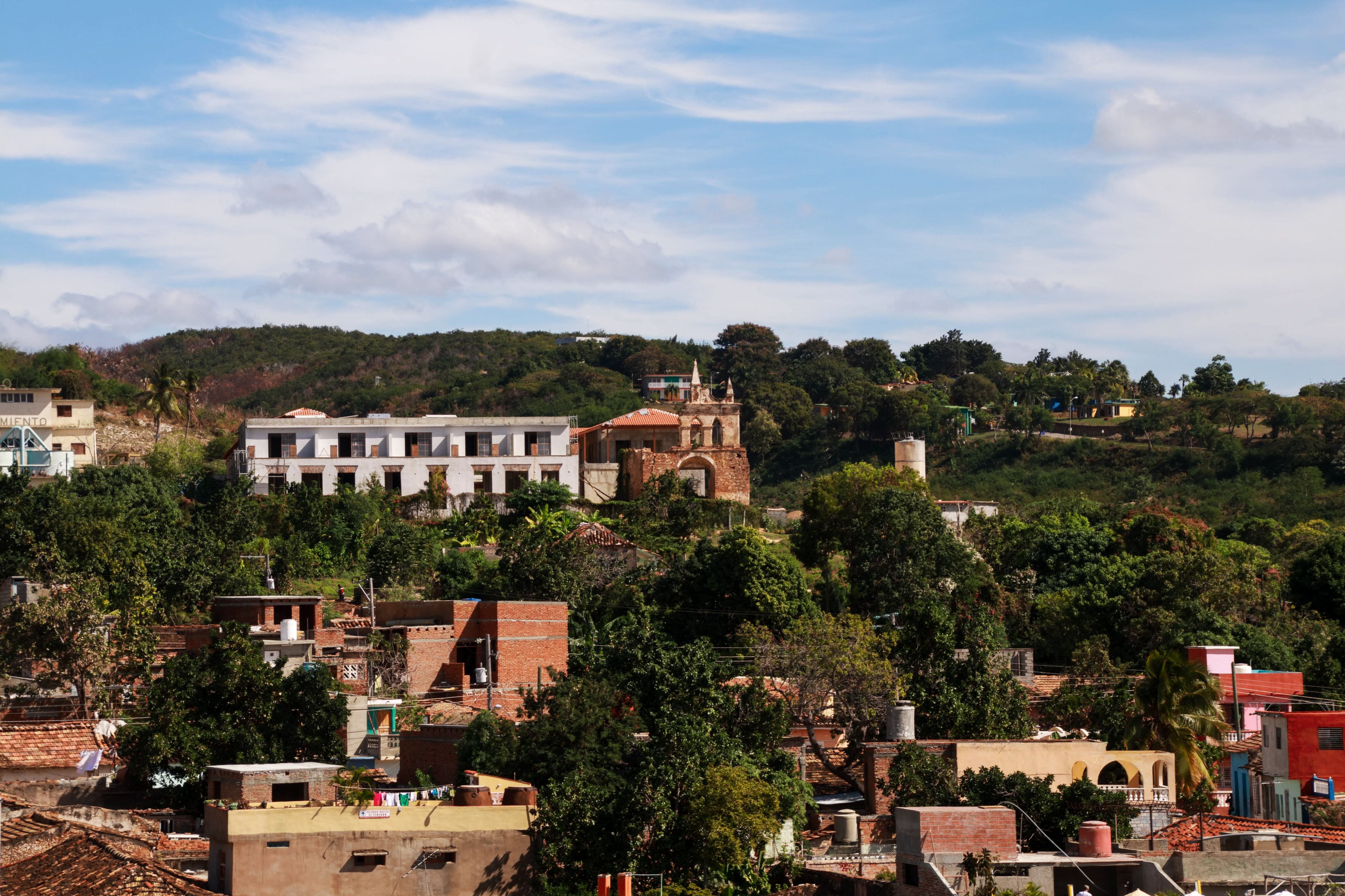 Aerial View of a Town between a Few Hills on a Flat Land · Free Stock Photo