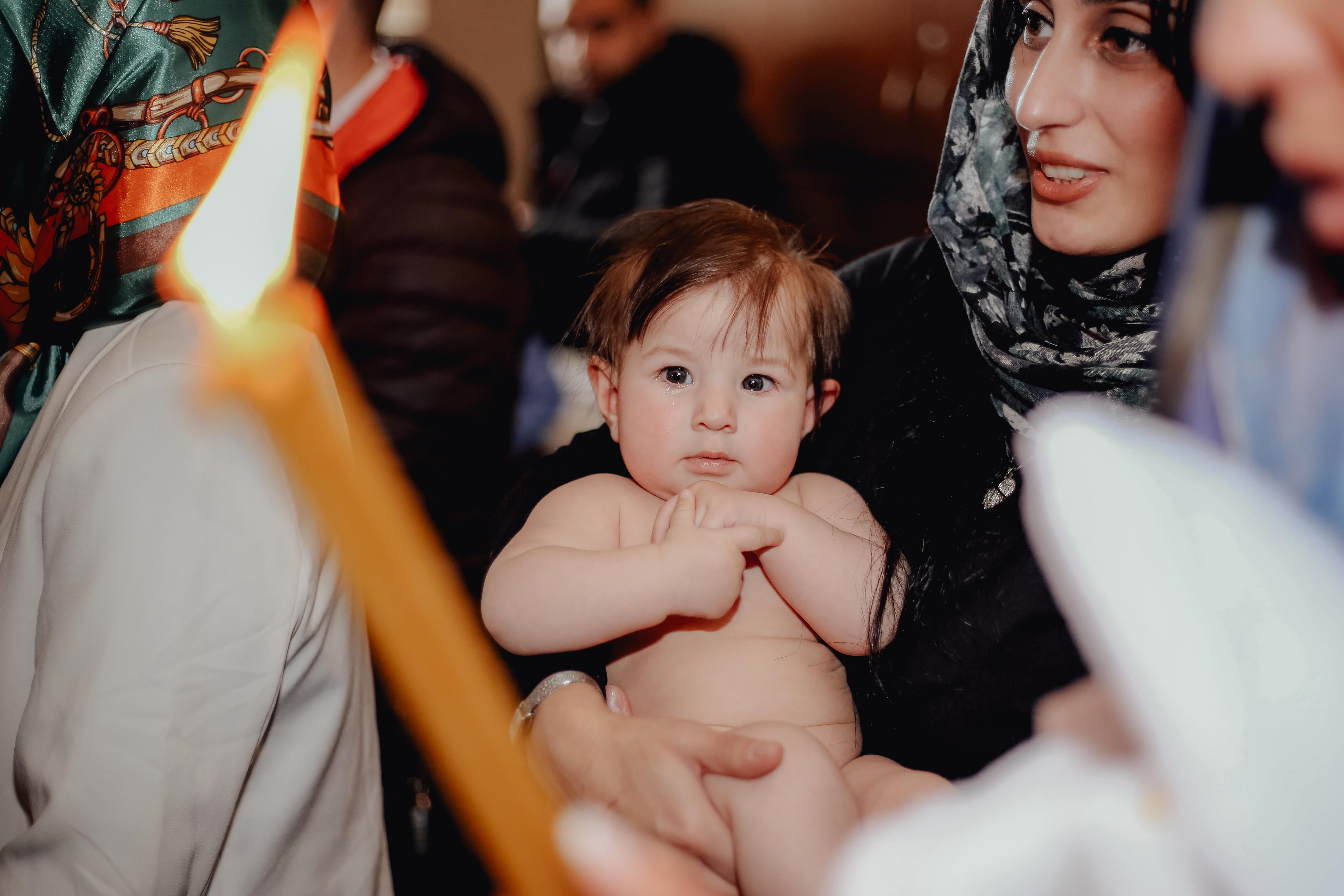 Woman Carrying a Baby · Free Stock Photo