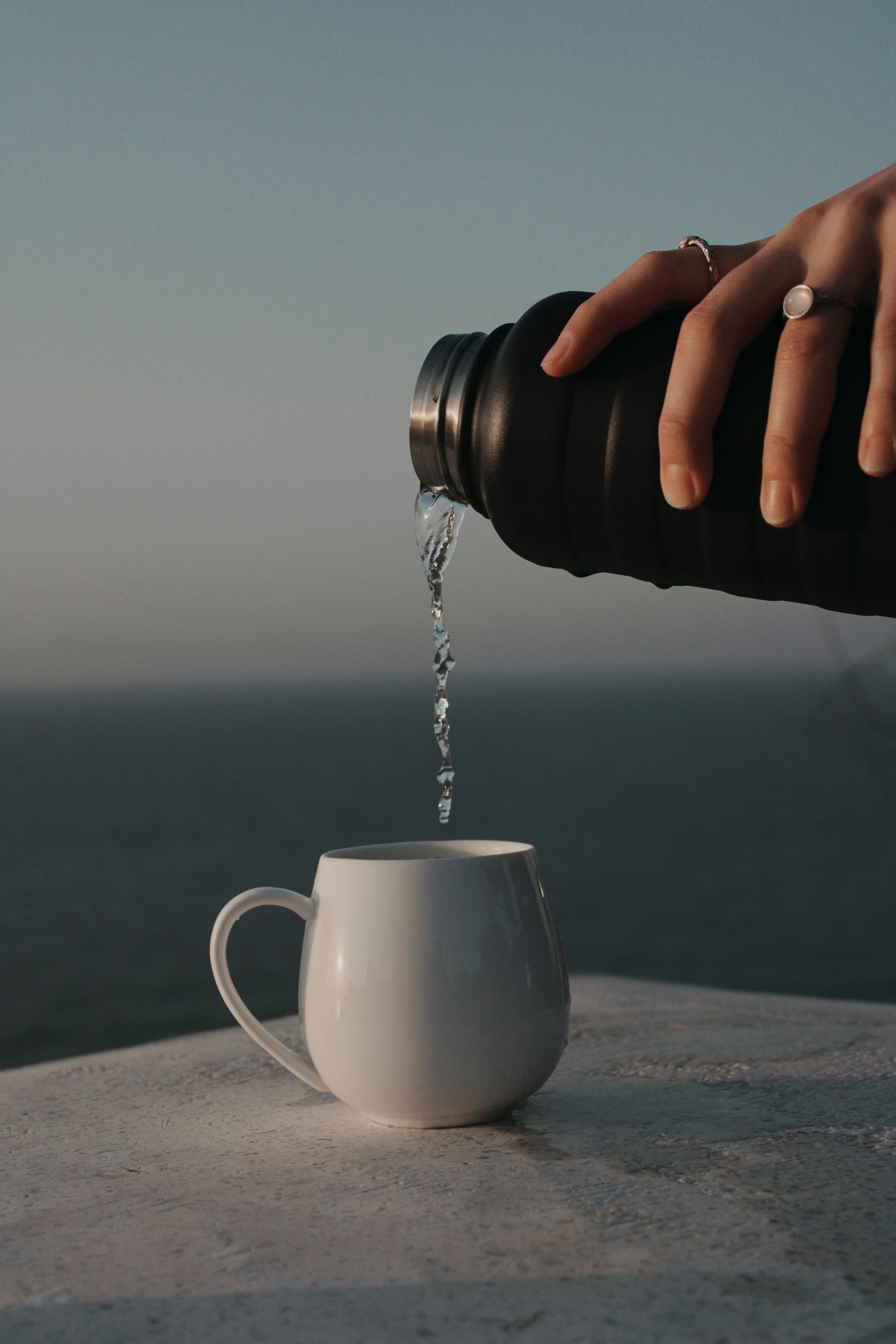 Person Pouring Water into Cup · Free Stock Photo