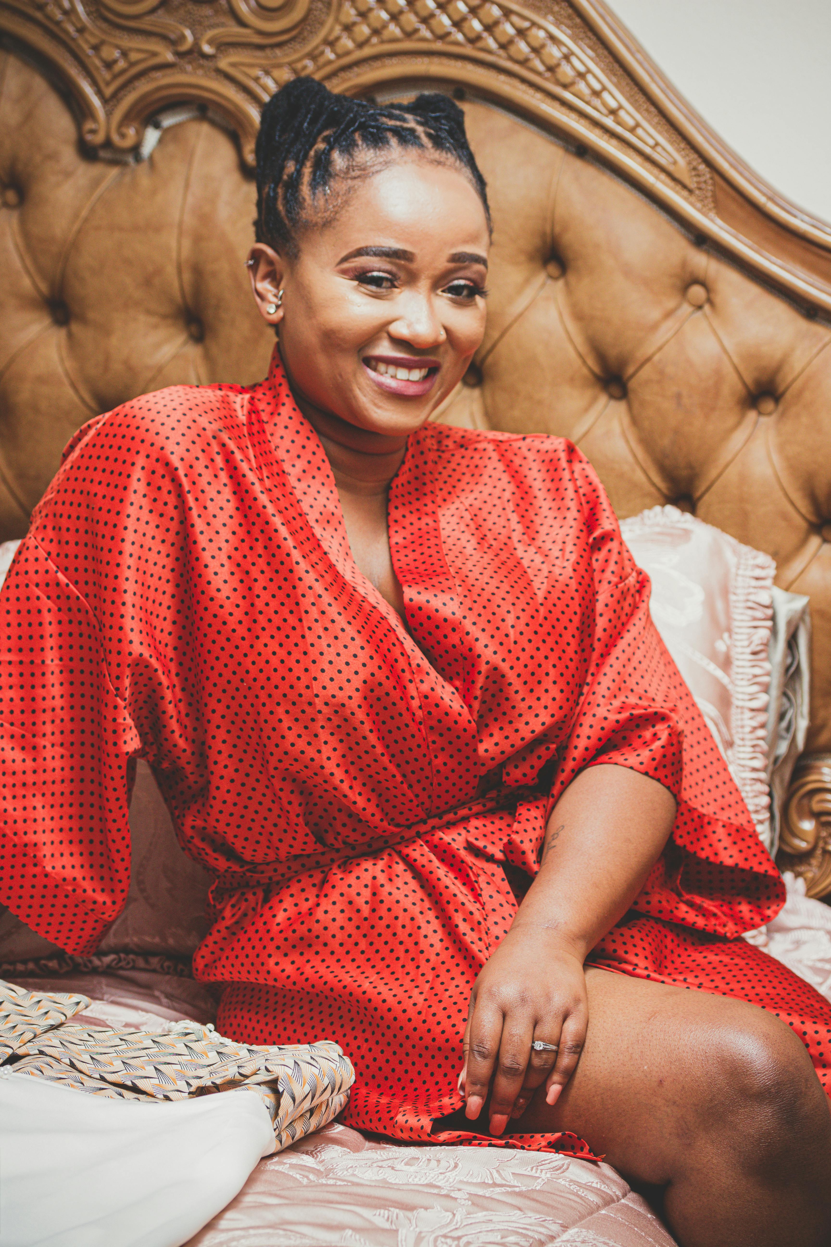 A Woman in Red Robe Sitting on the Bed · Free Stock Photo