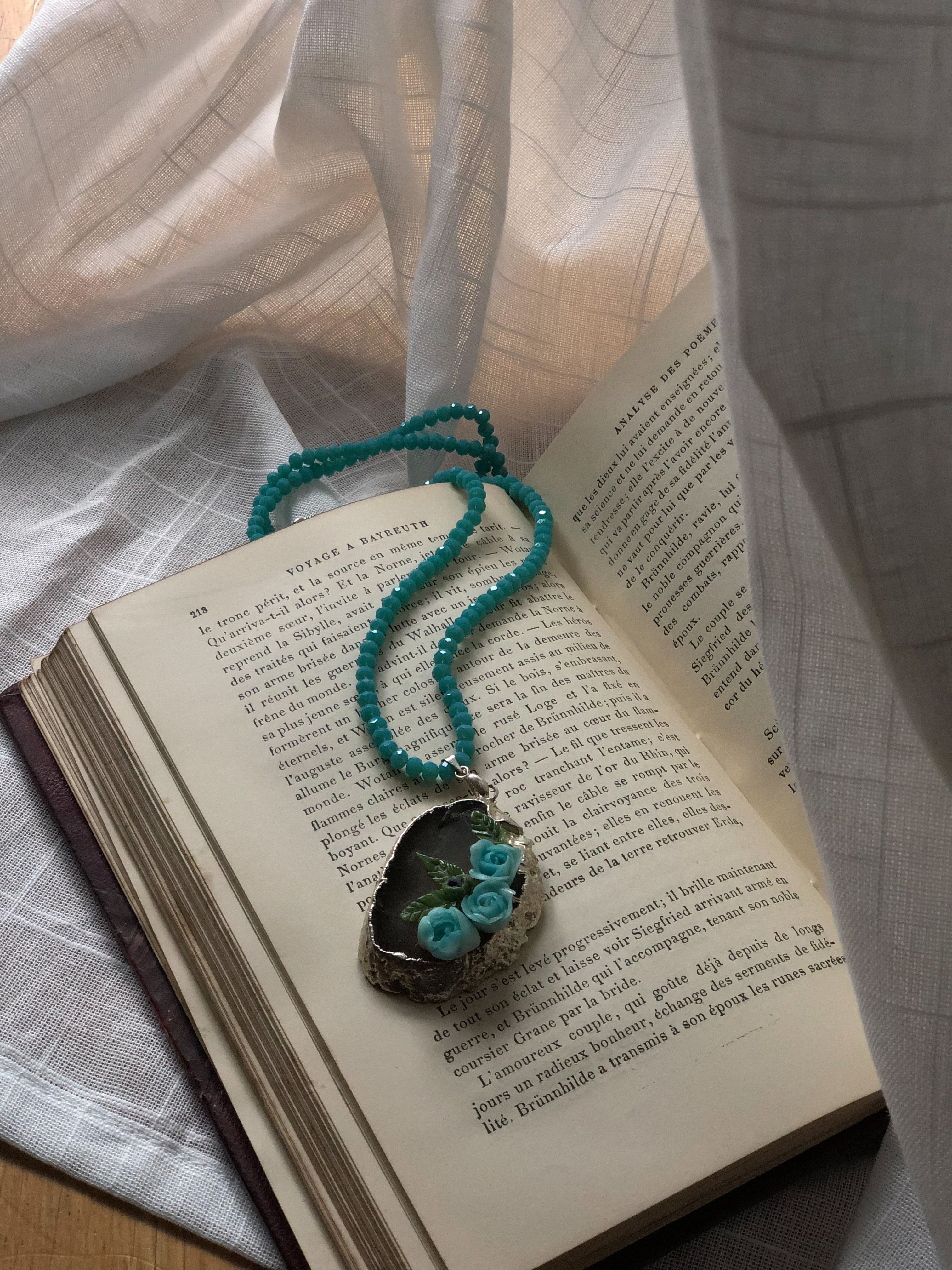 A Resin Pendant on an Open Book · Free Stock Photo