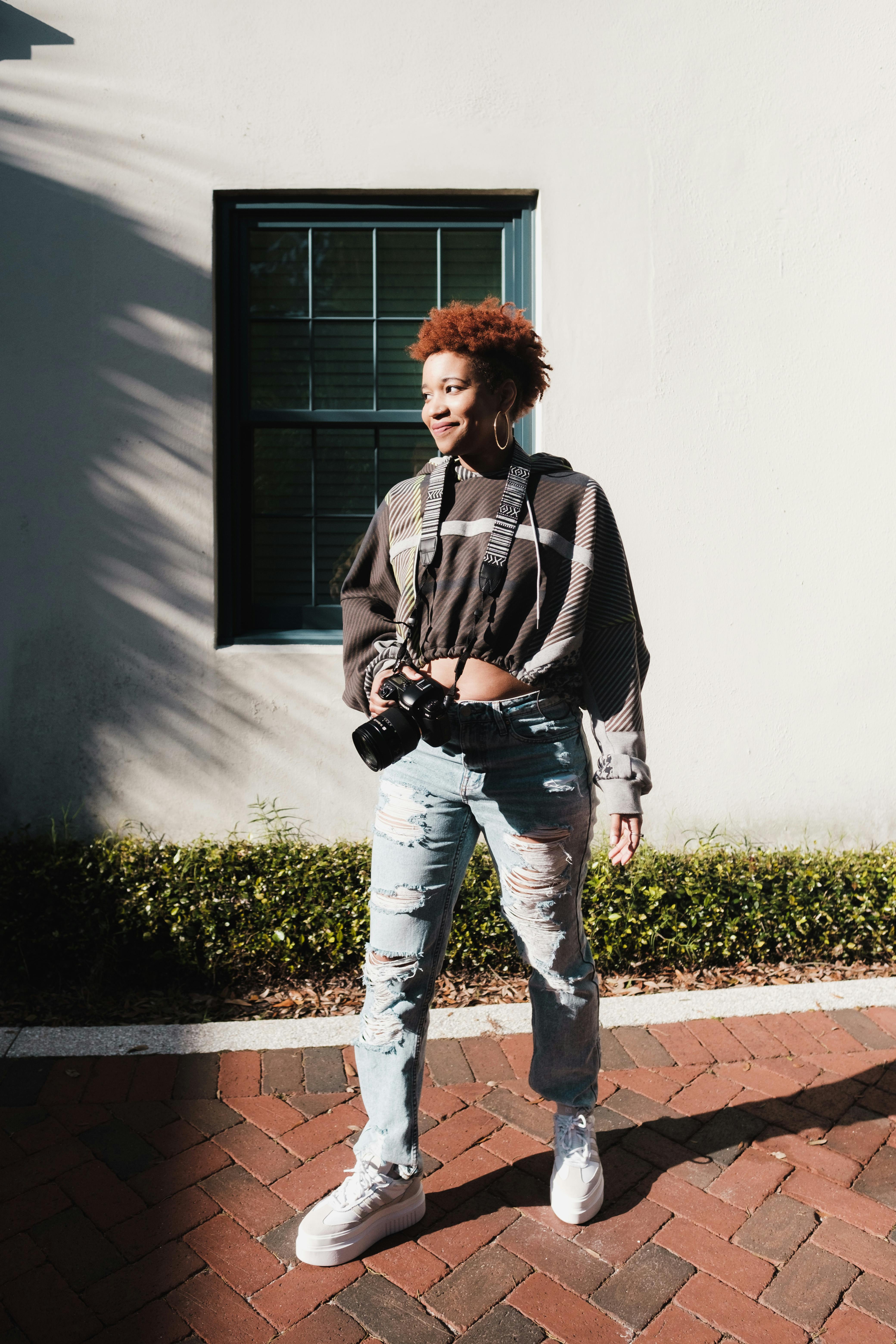 Smiling Woman Photographer Holding Camera · Free Stock Photo