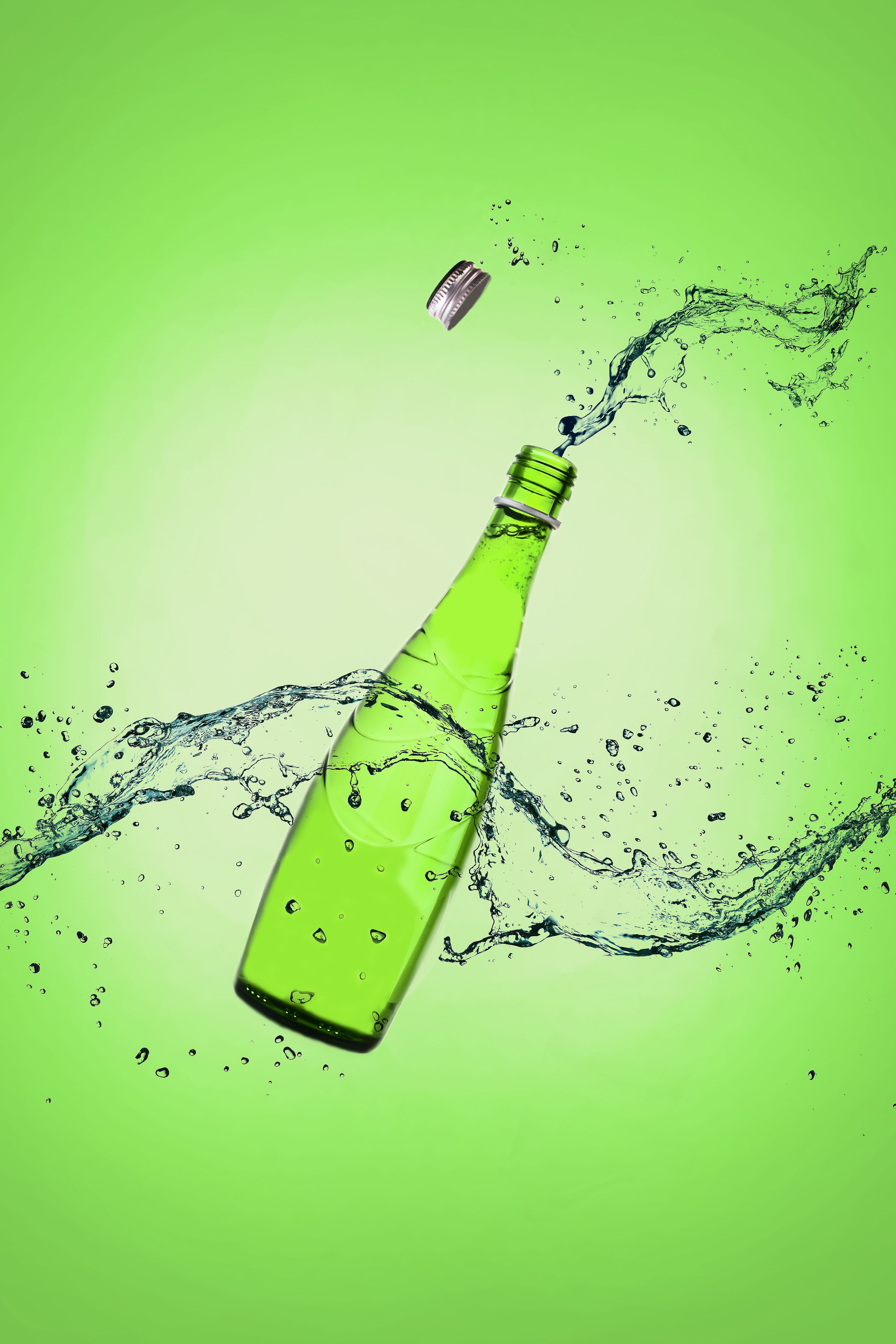 Green Glass Bottle With Water Splash · Free Stock Photo