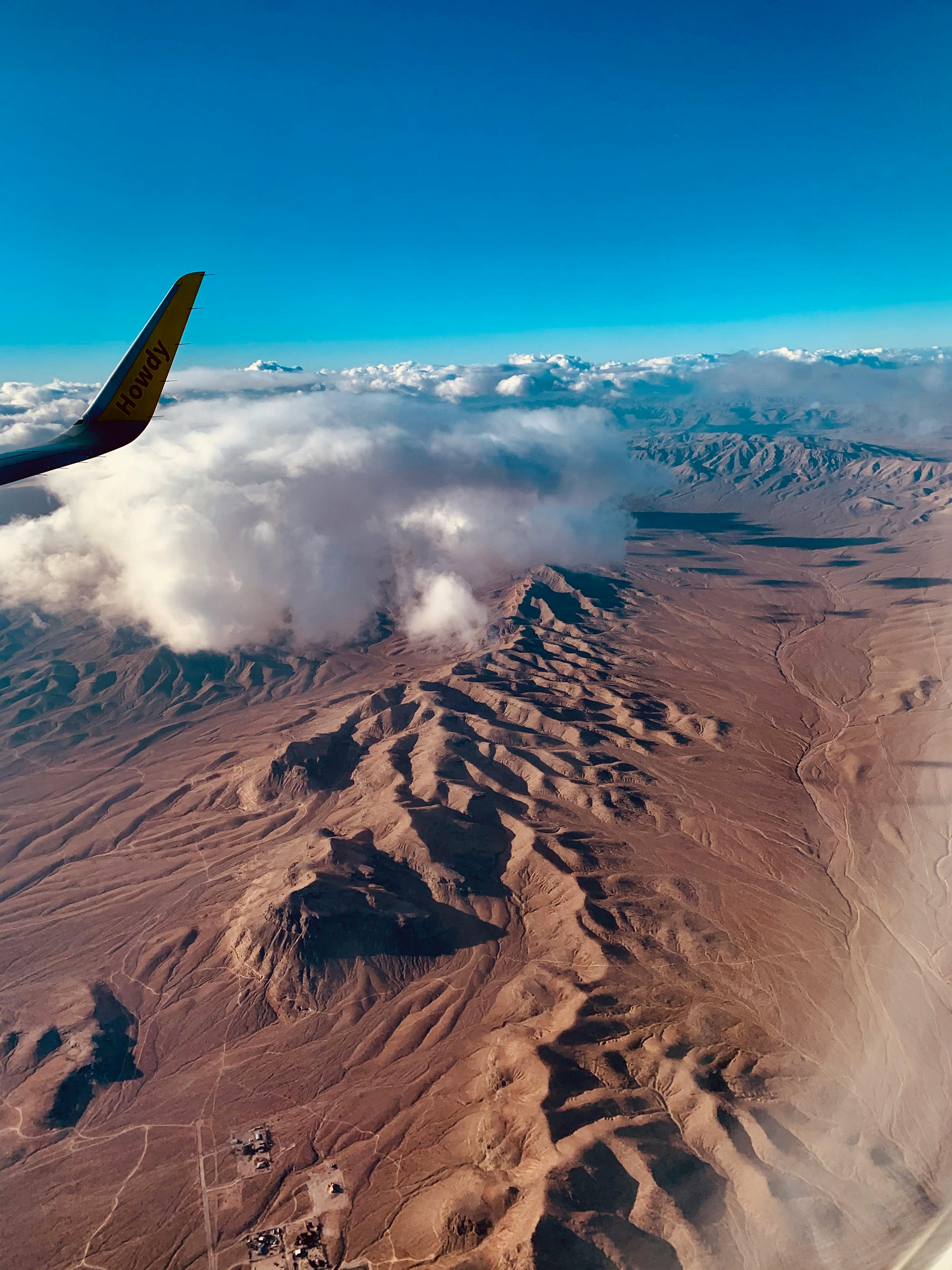 The View of the Desert and Clouds from the Airplane · Free Stock Photo