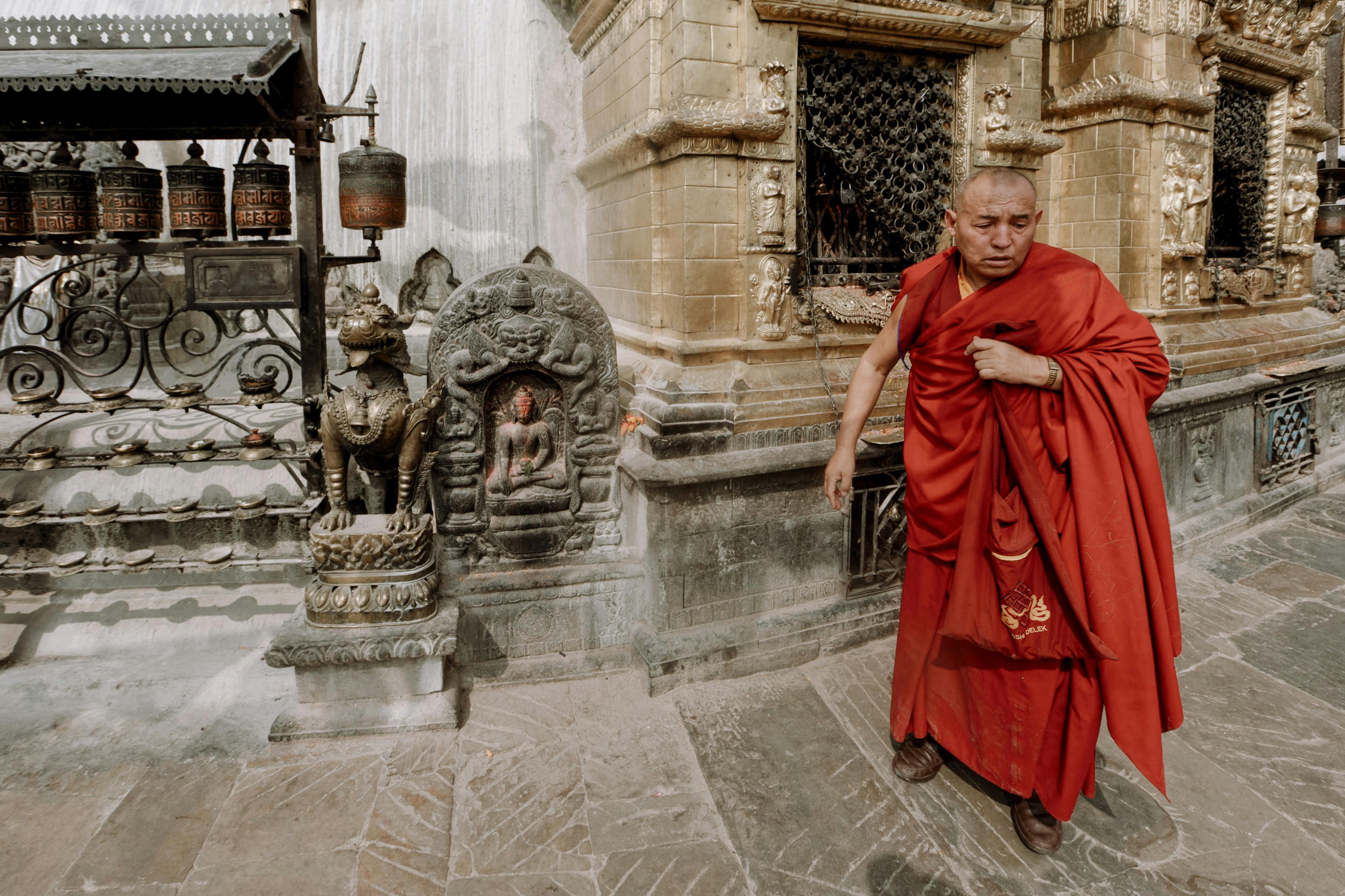 A Monk in Traditional Wear Standing Outside the Temple · Free Stock Photo
