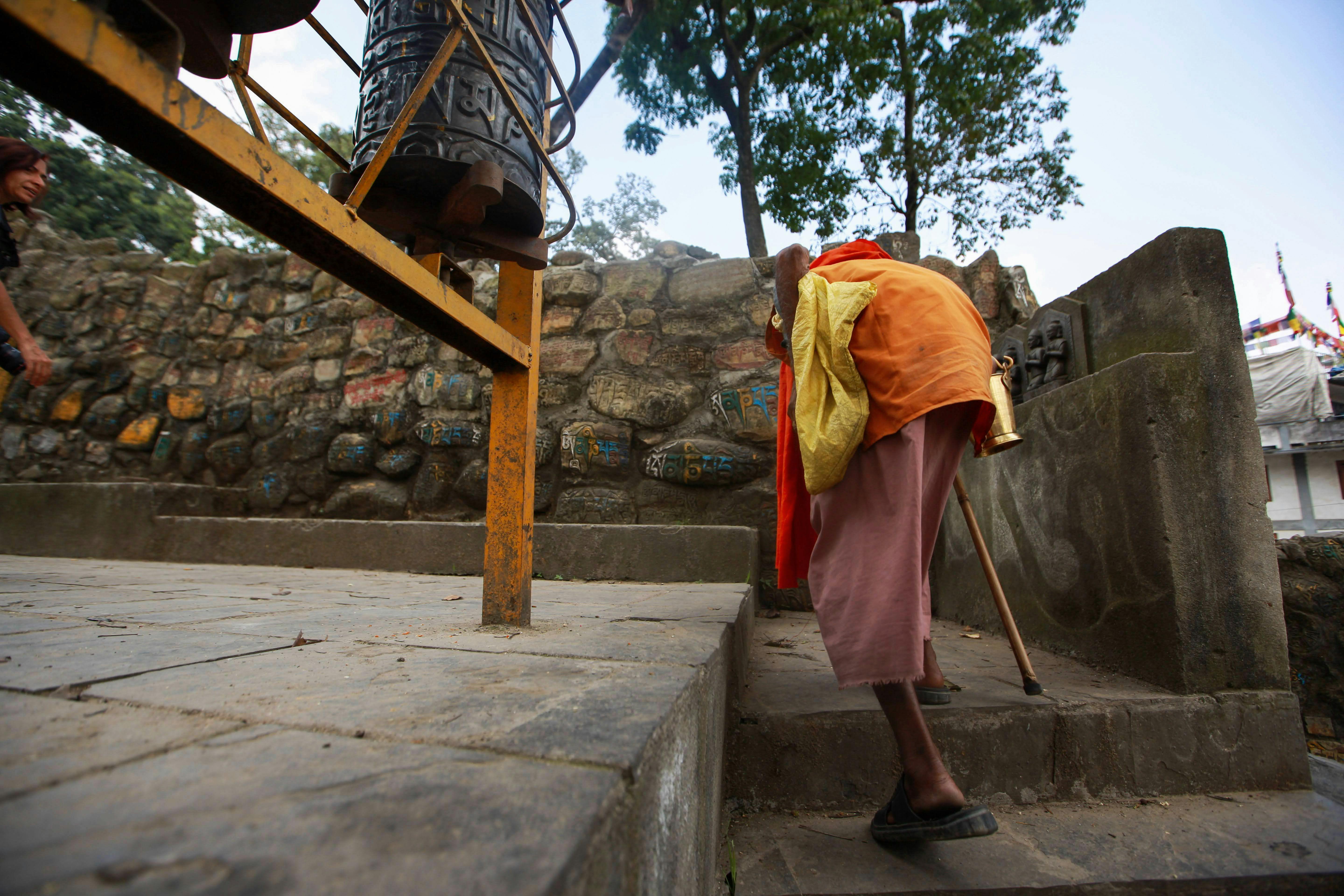 A Monk Walking Down the Stairs · Free Stock Photo