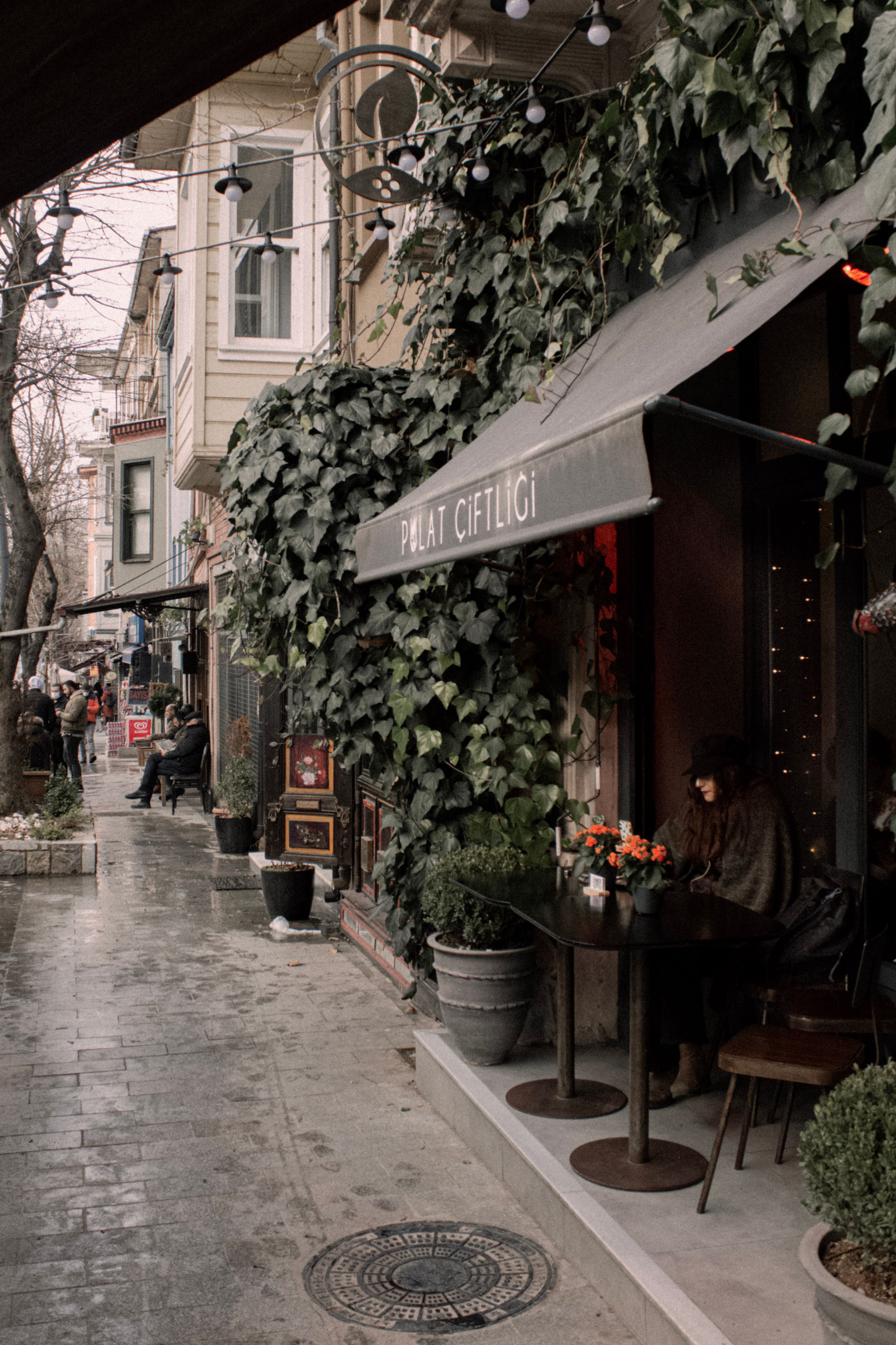 Exterior of stylish coffee shop with glass wall and street terrace ...
