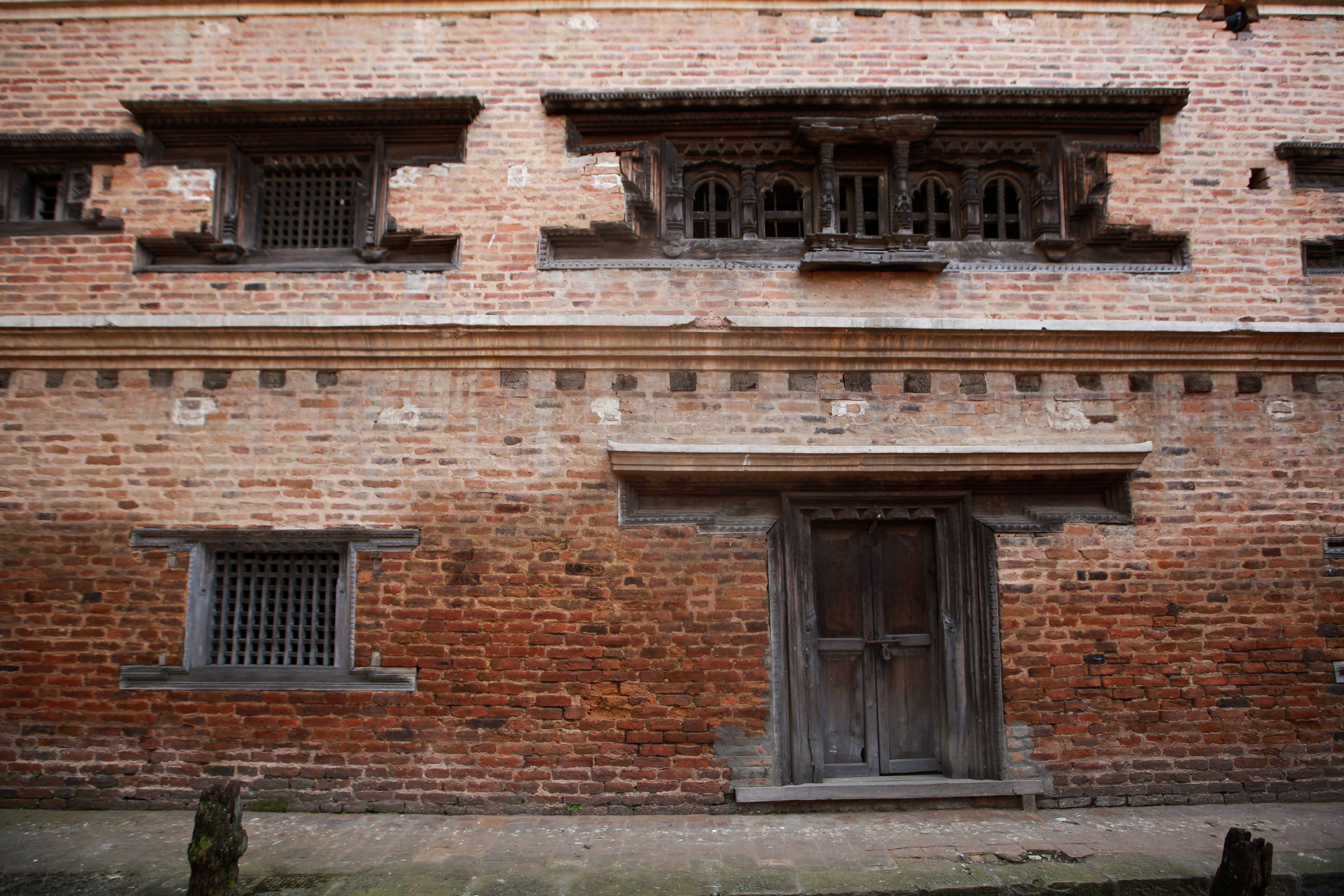 A Brick Building with Wooden Doors and Windows · Free Stock Photo