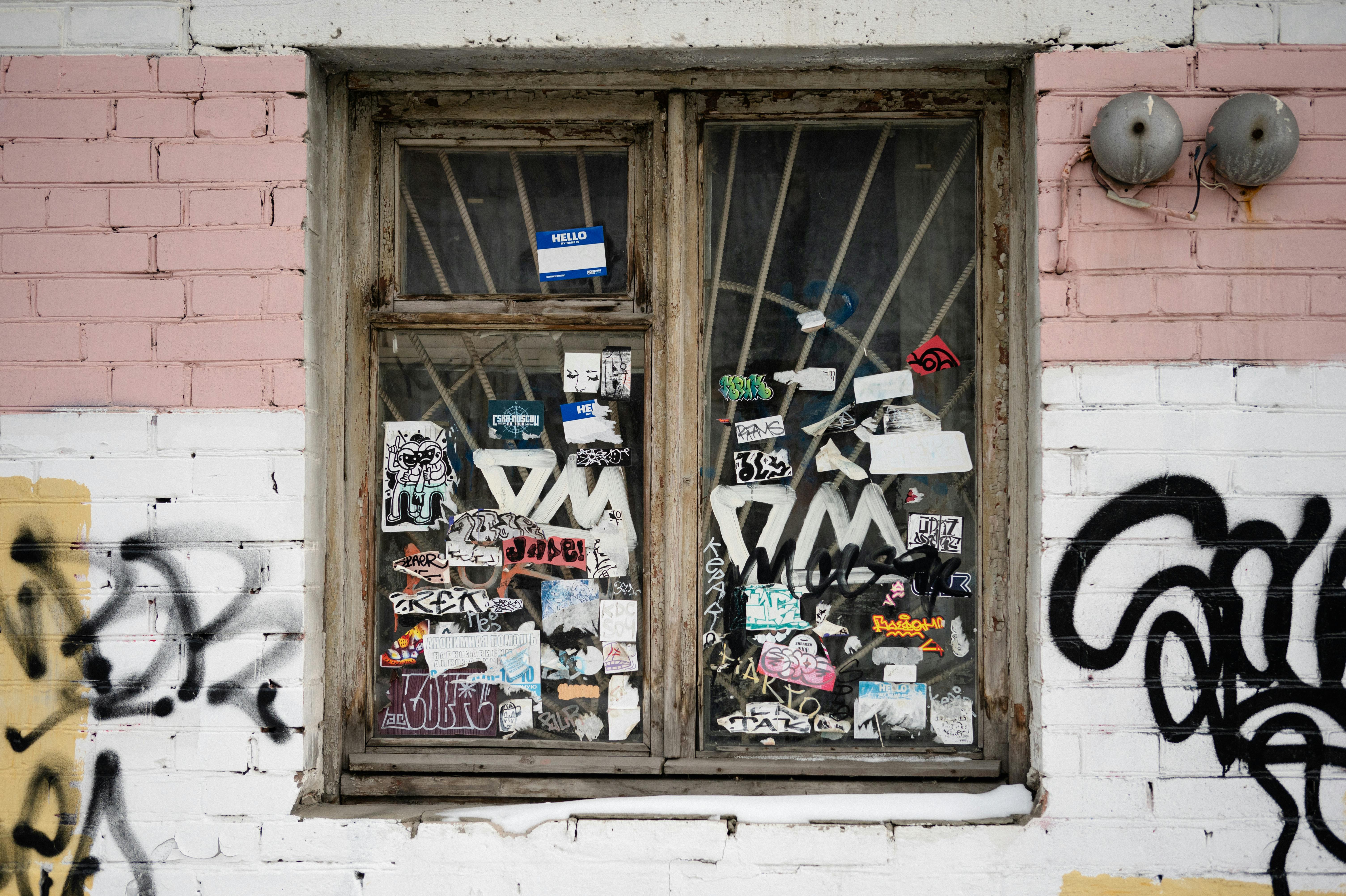 Graffiti and Stickers on a Window · Free Stock Photo