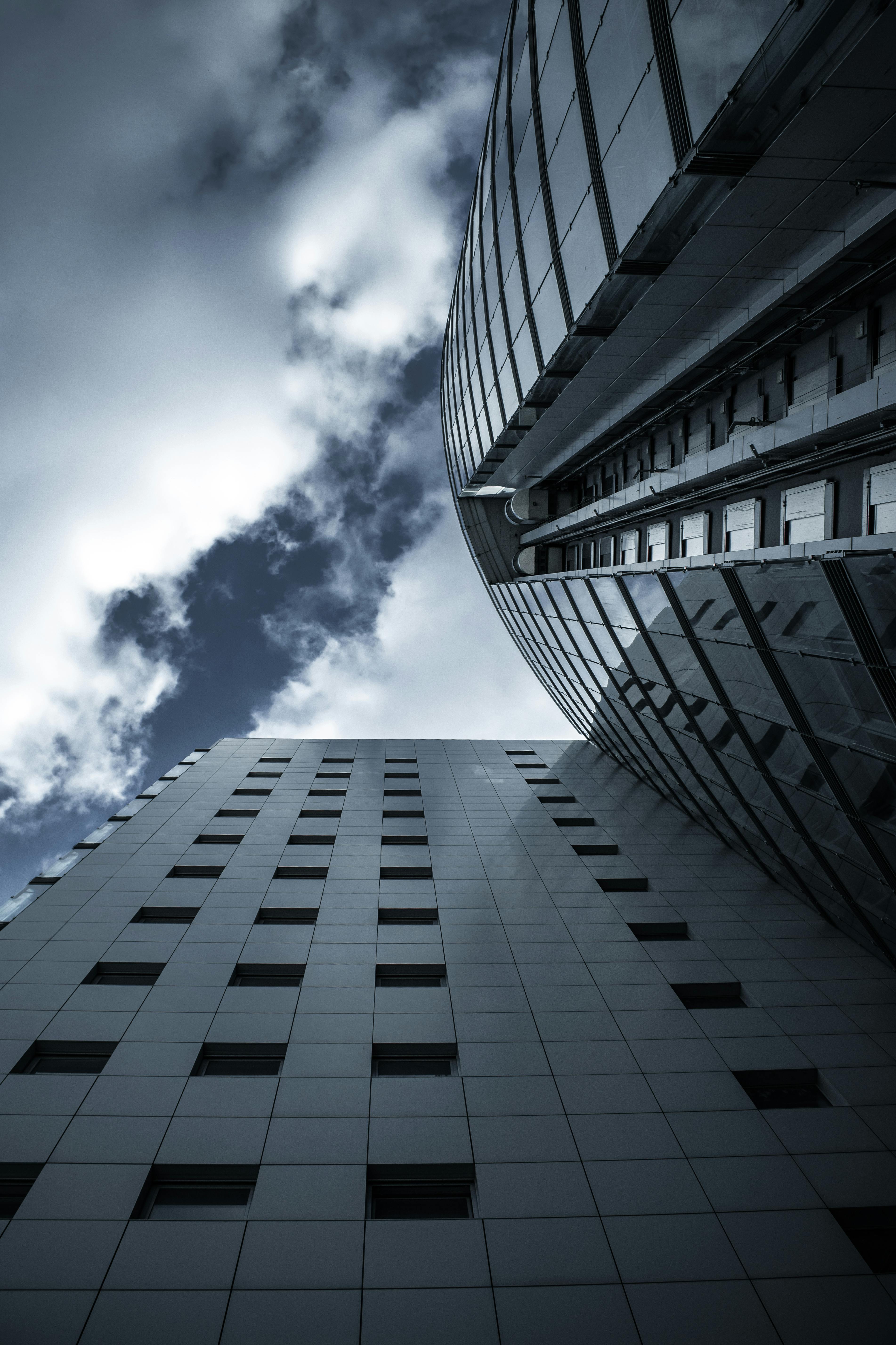 A Low Angle Photography Buildings Under the Cloudy Sky · Free Stock Photo