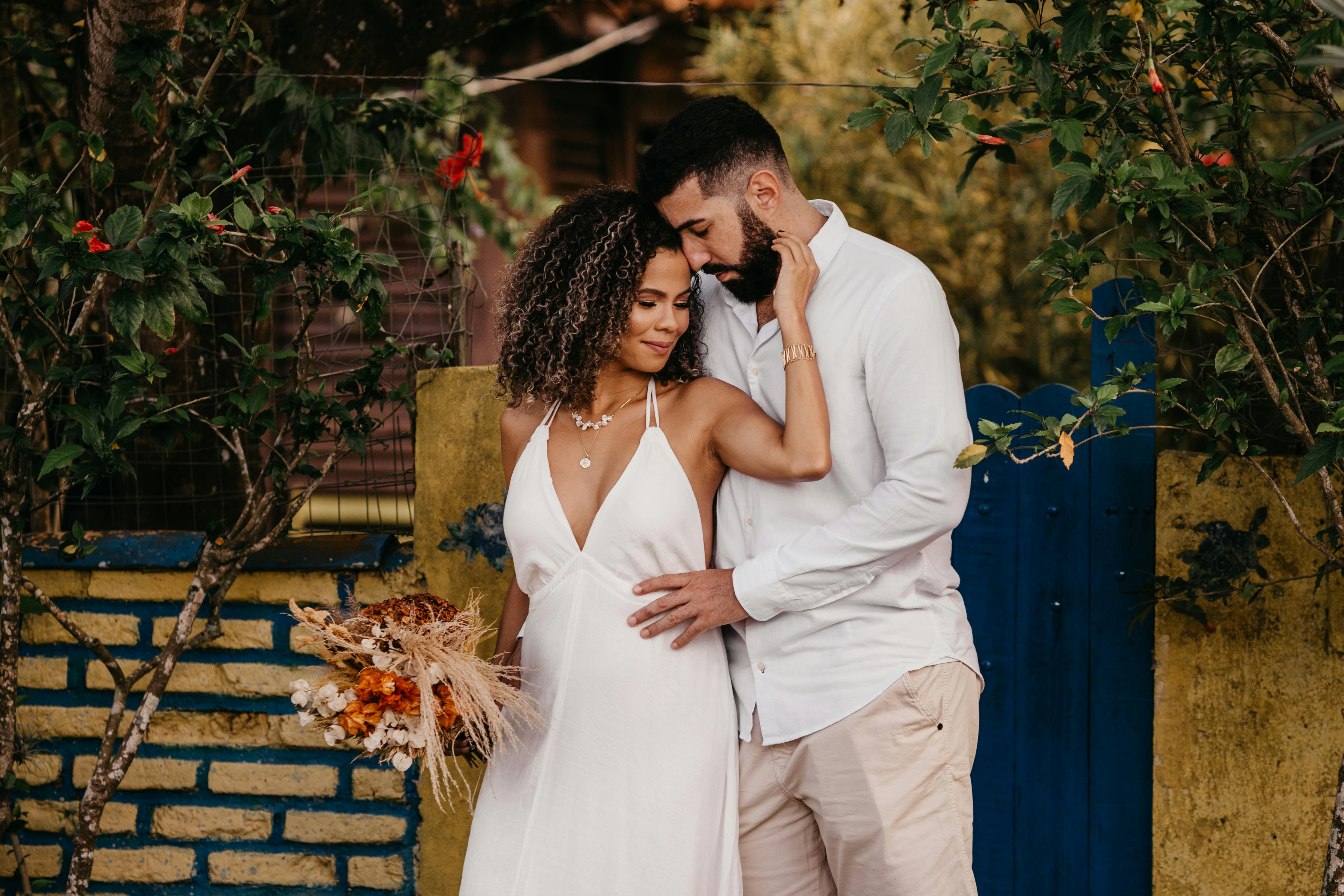 Bride and Bridegroom Embracing on their Wedding Day · Free Stock Photo