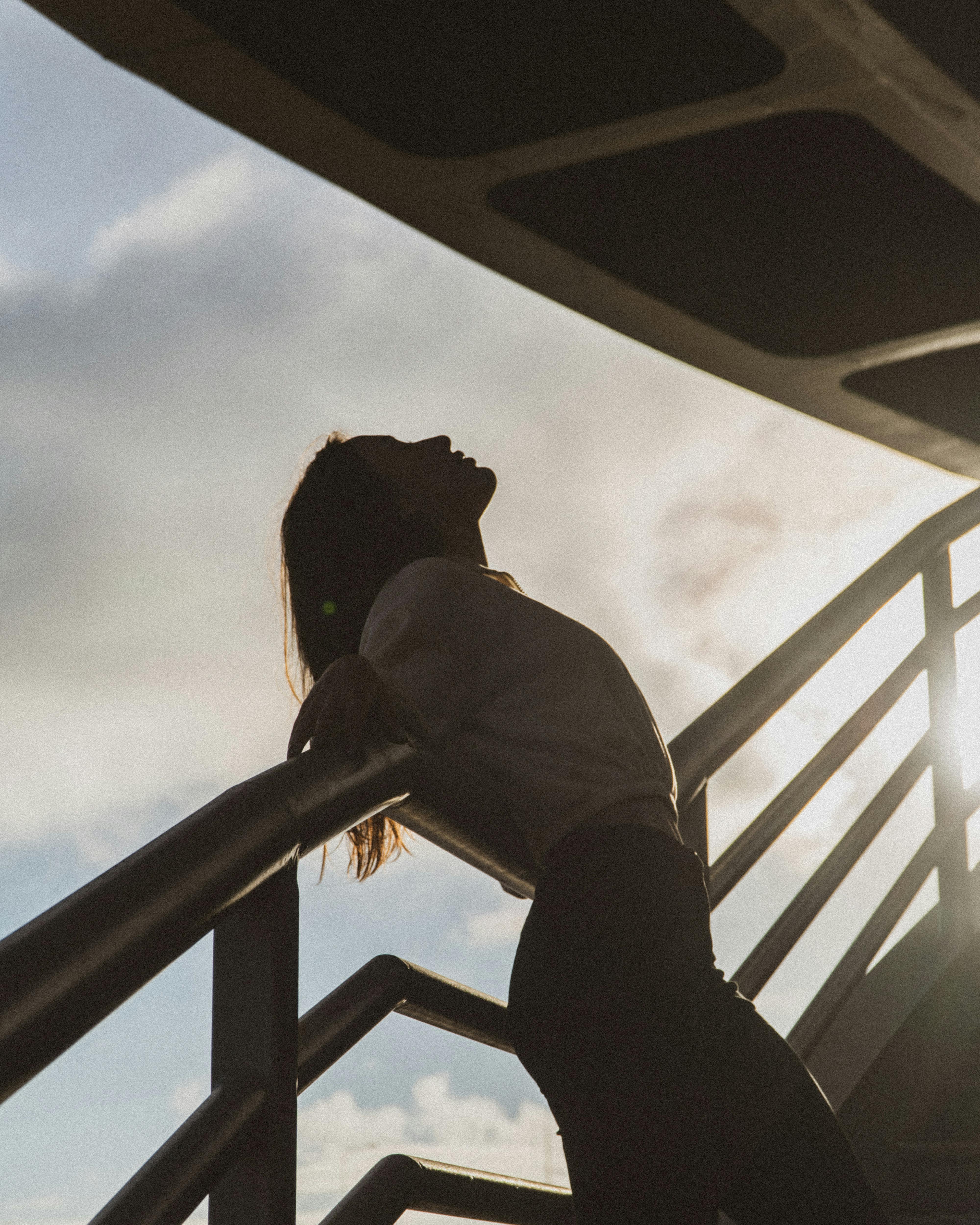 Woman Leaning on a Railing · Free Stock Photo