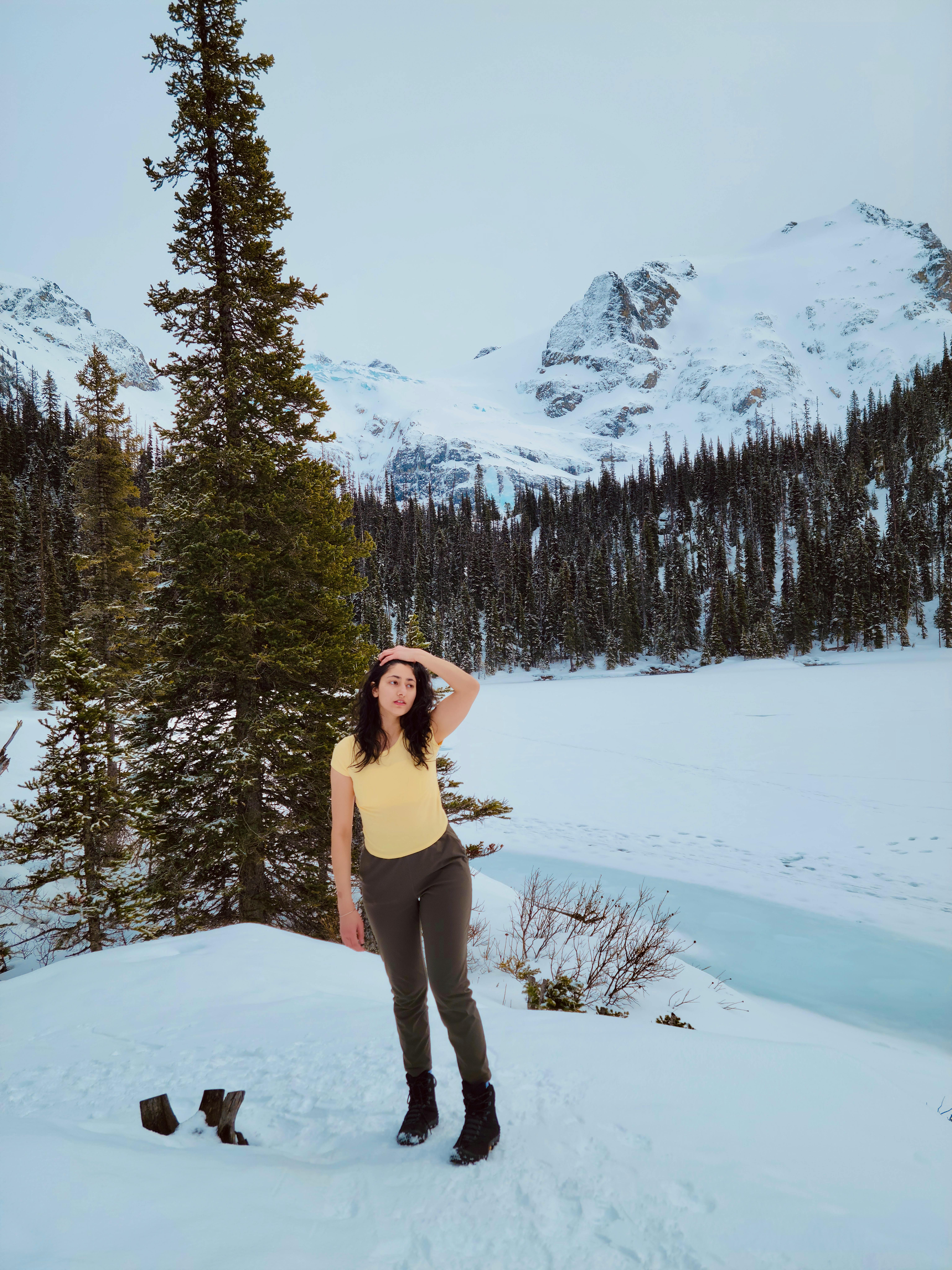 A Woman Standing on a Snow Covered Ground · Free Stock Photo