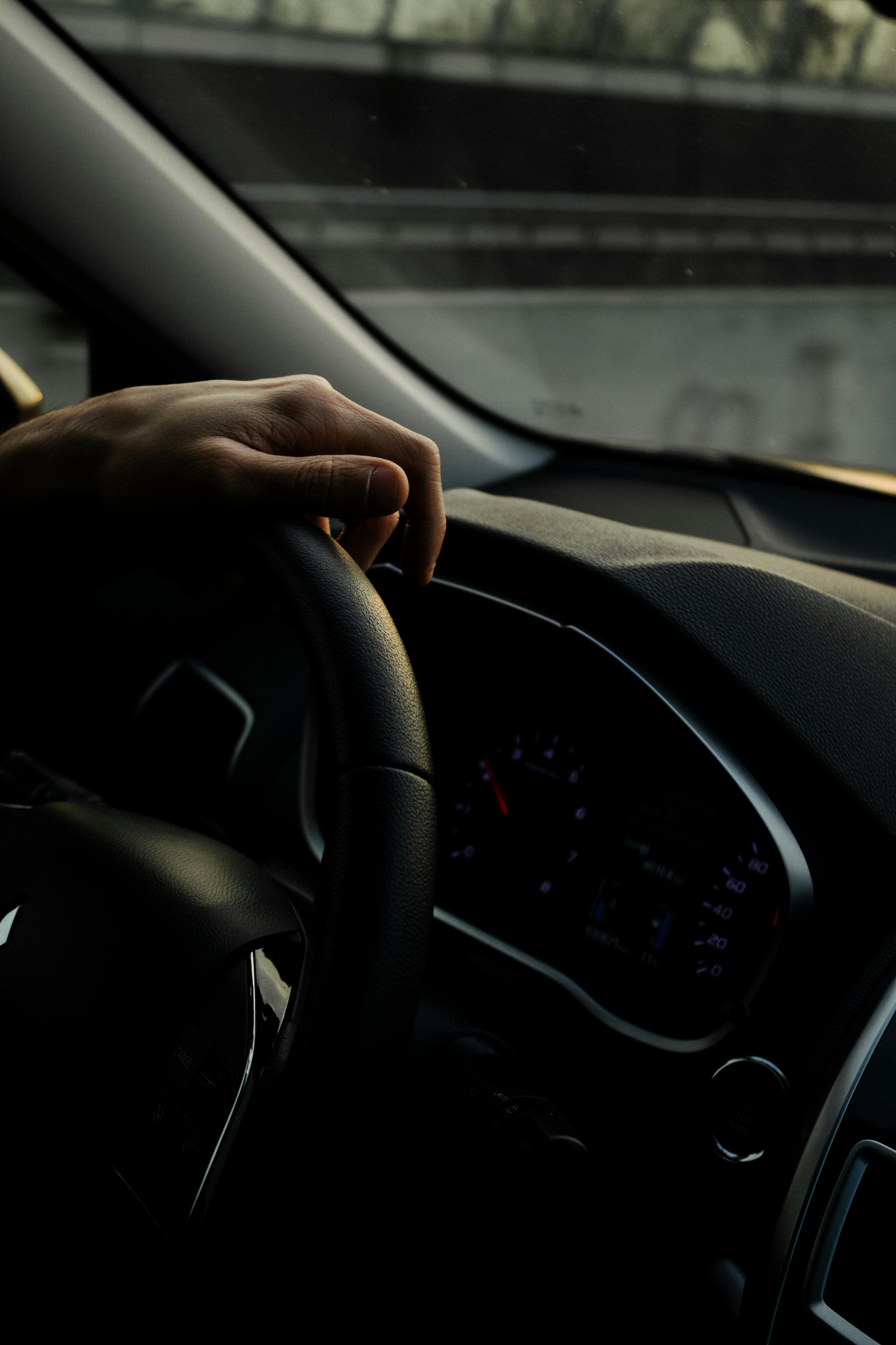 Close-Up Shot of a Person Driving a Car · Free Stock Photo