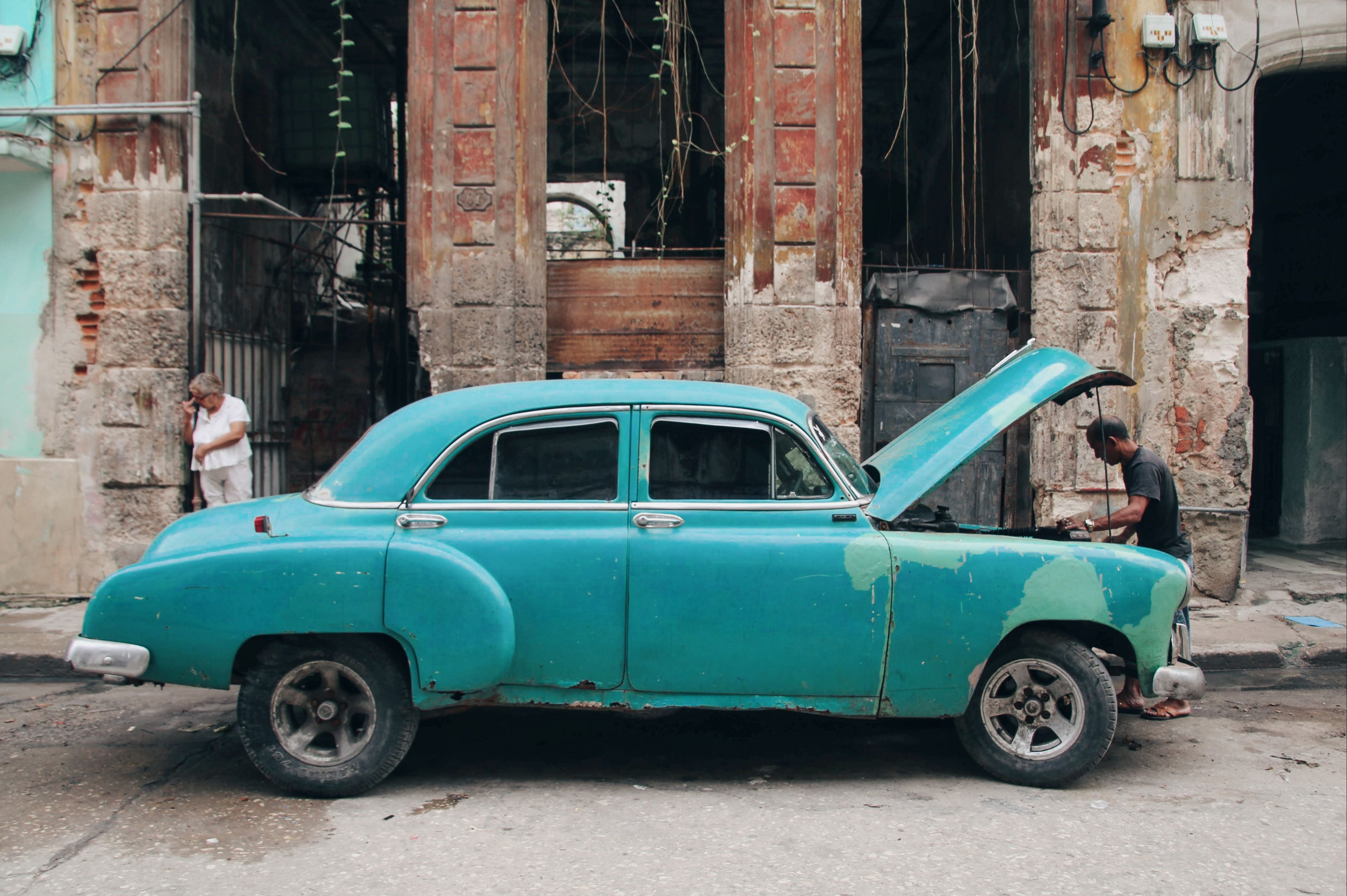 Man Repairing Blue Car on Roadside · Free Stock Photo