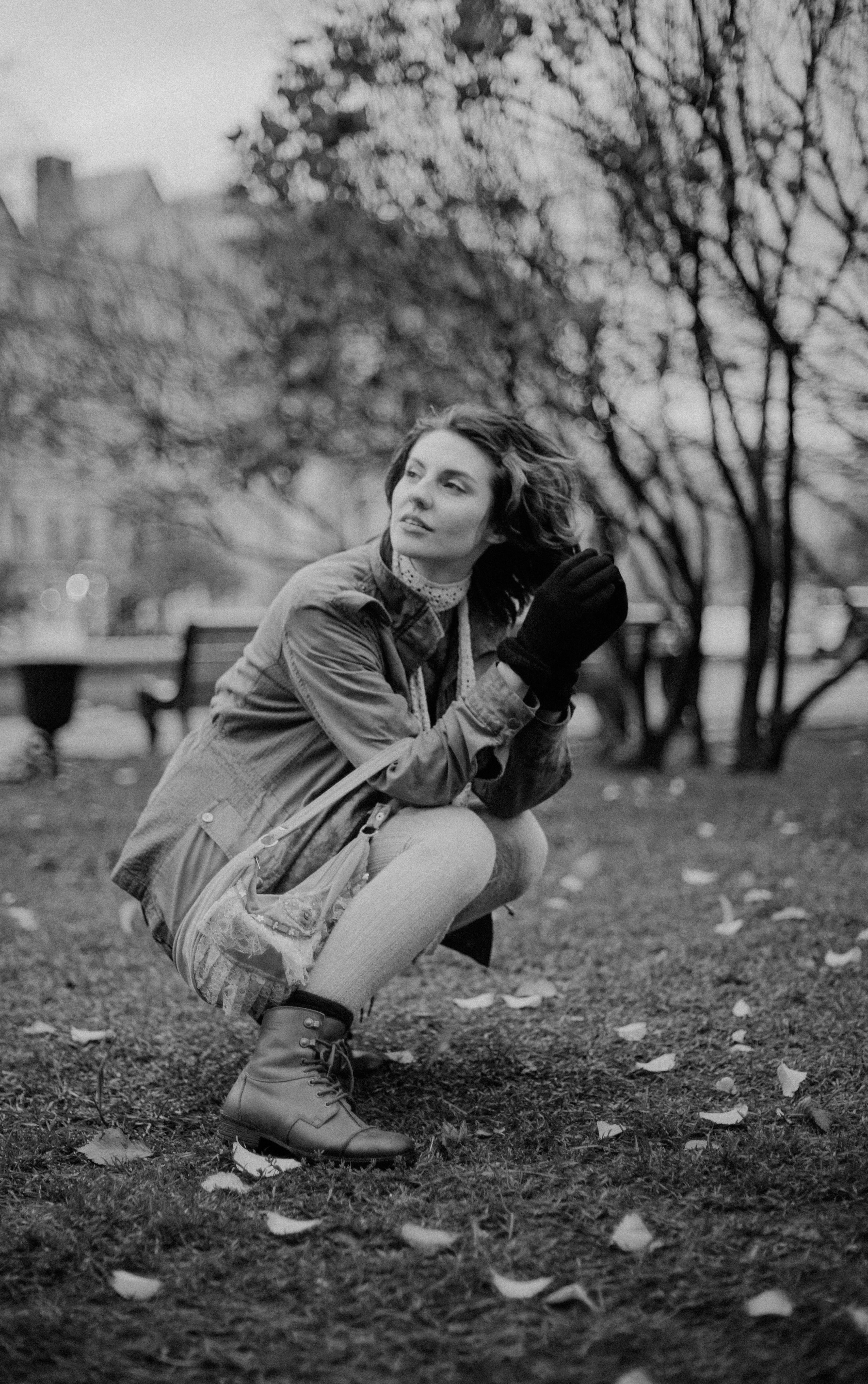 Woman Crouching in Park · Free Stock Photo