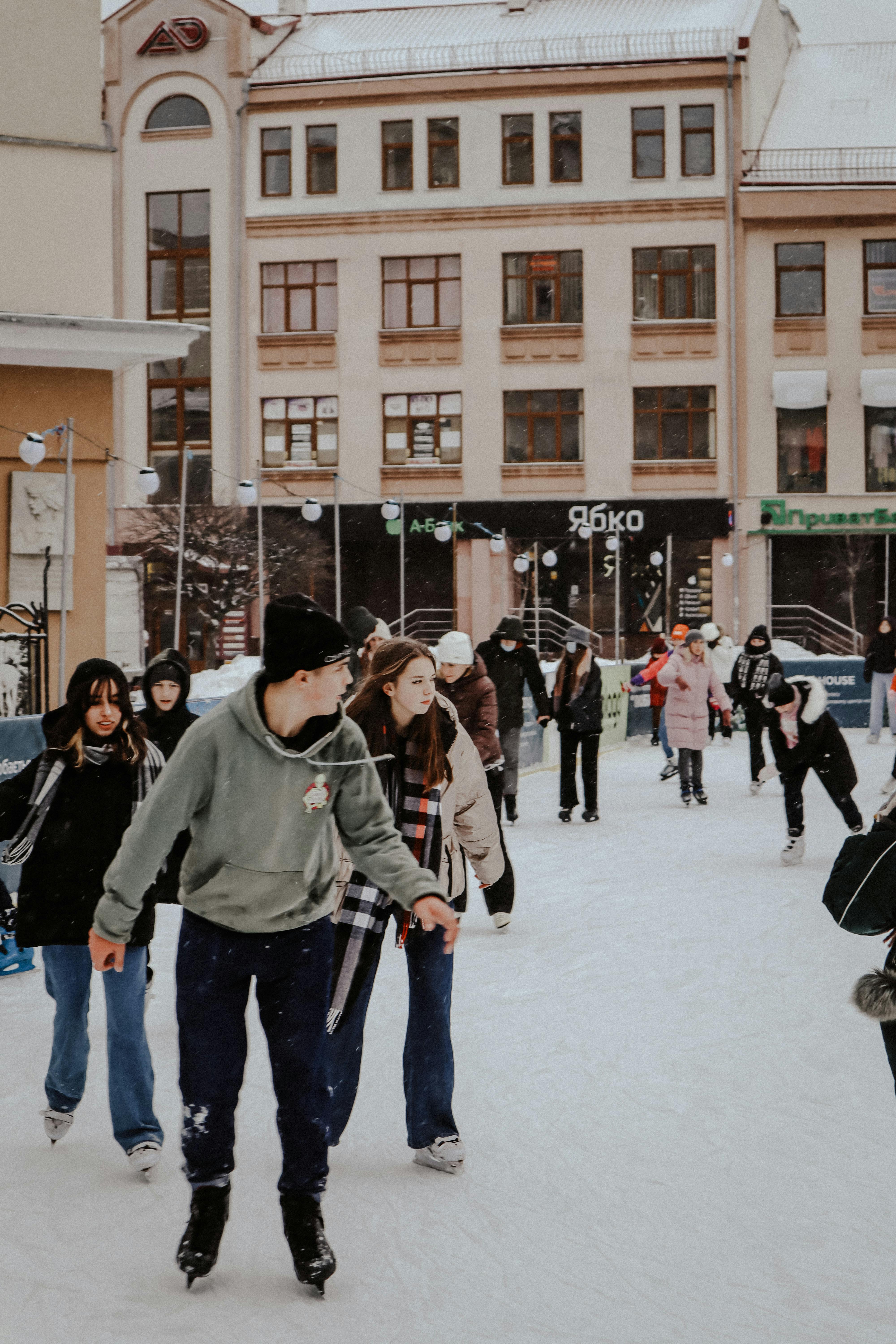 People Ice Skating Near Buildings · Free Stock Photo