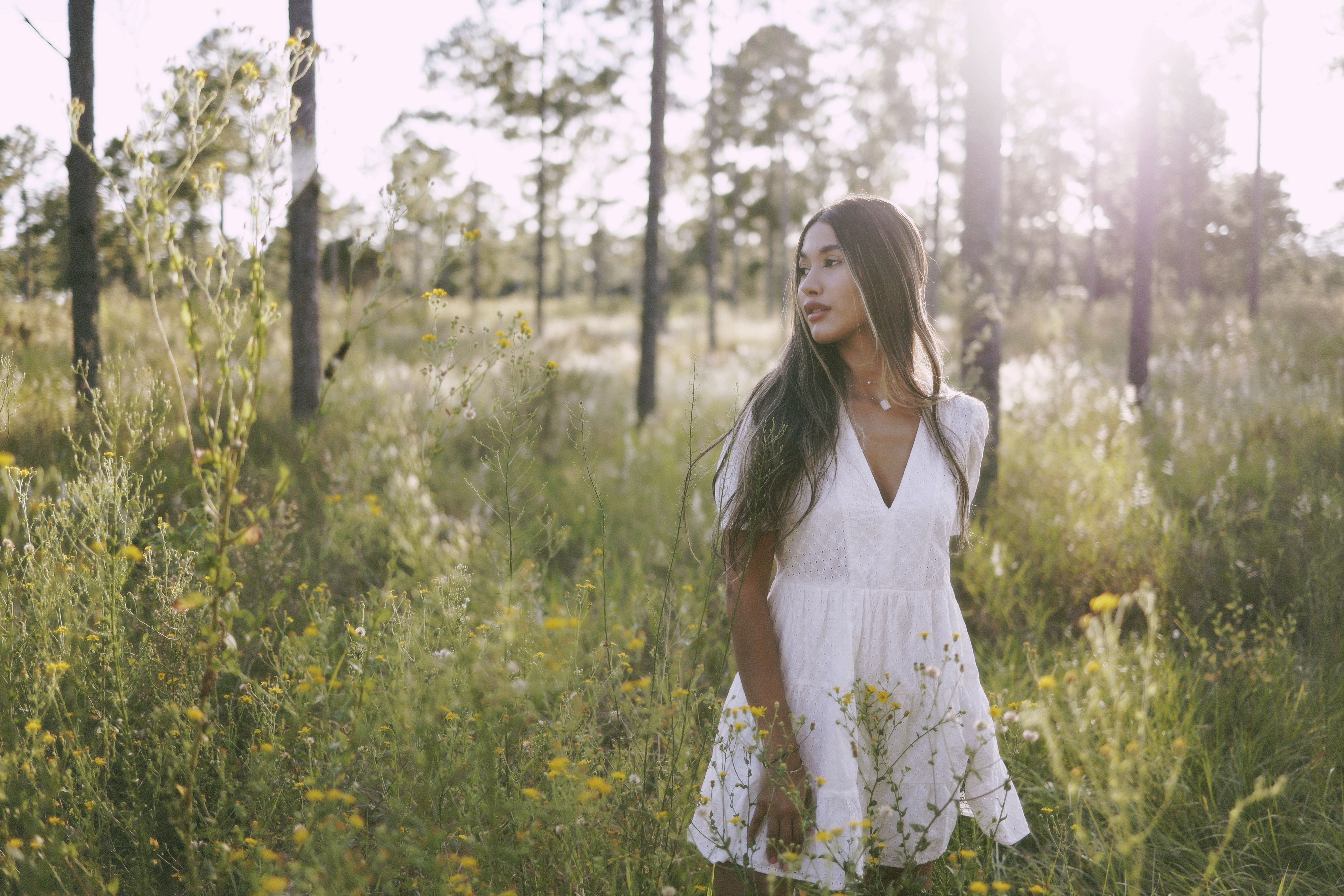 Woman in White Dress Walking Through Meadow · Free Stock Photo