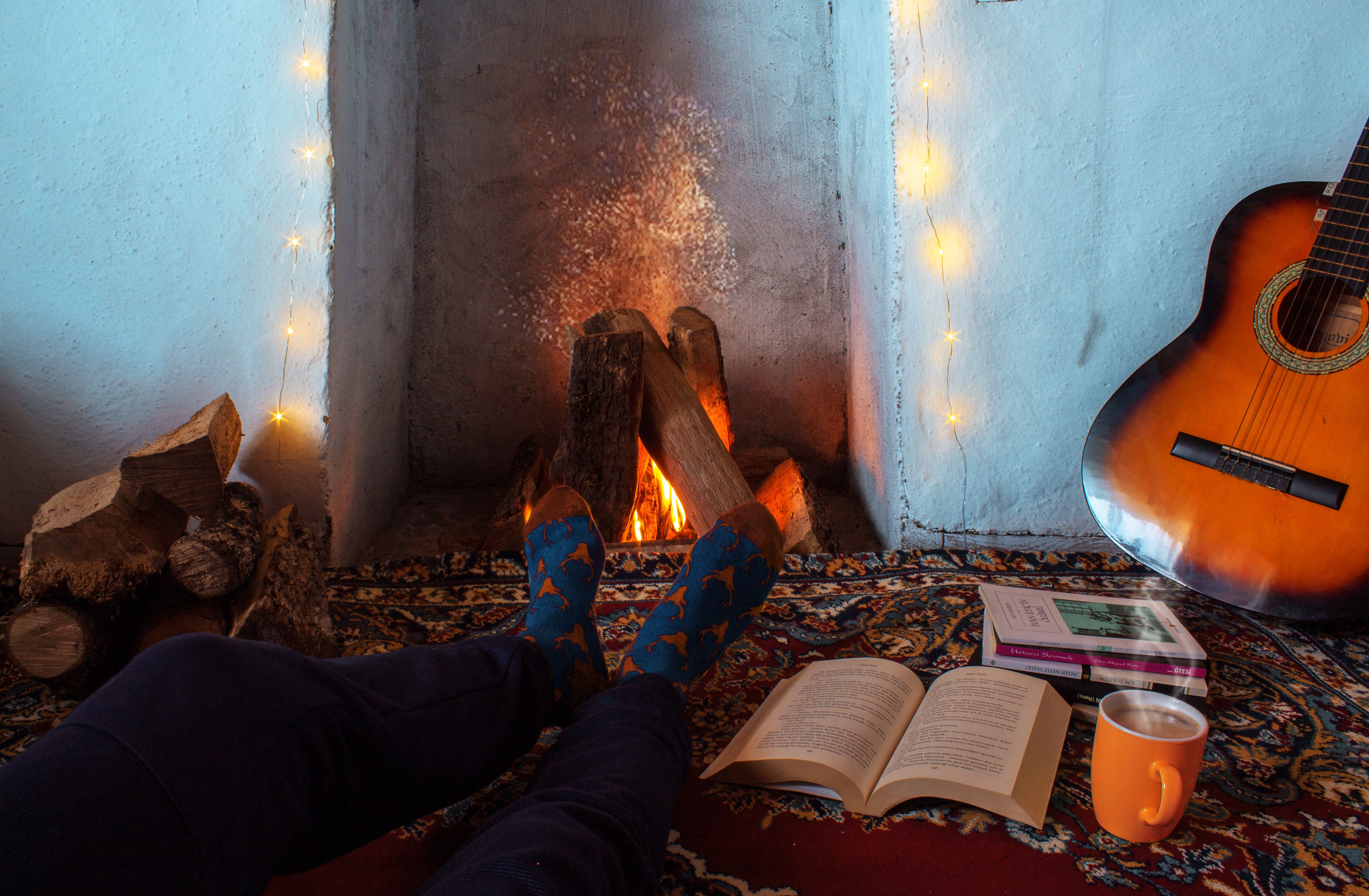 A Person Sitting Beside the Fireplace · Free Stock Photo