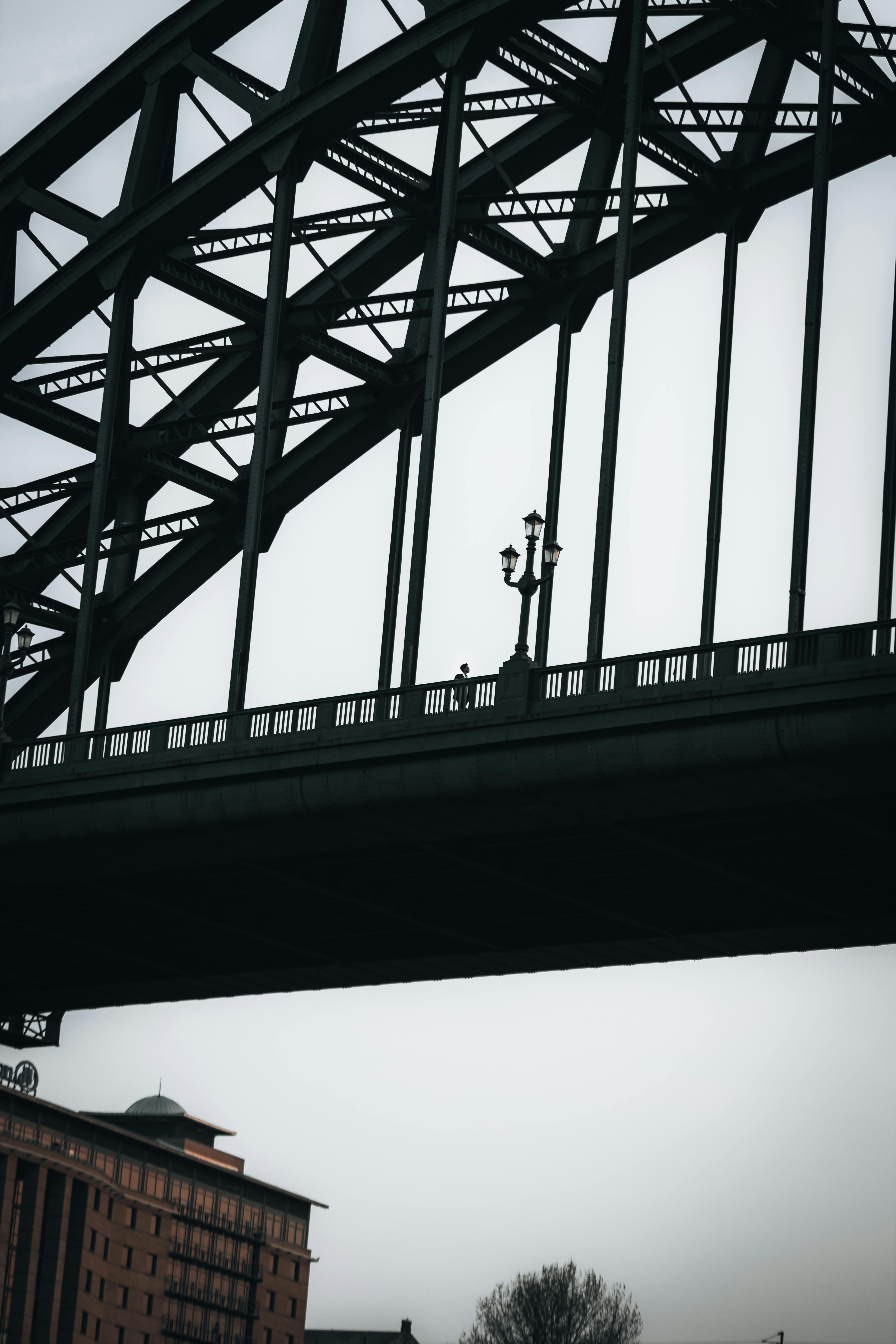 Silhouette of Man Crossing Bridge · Free Stock Photo