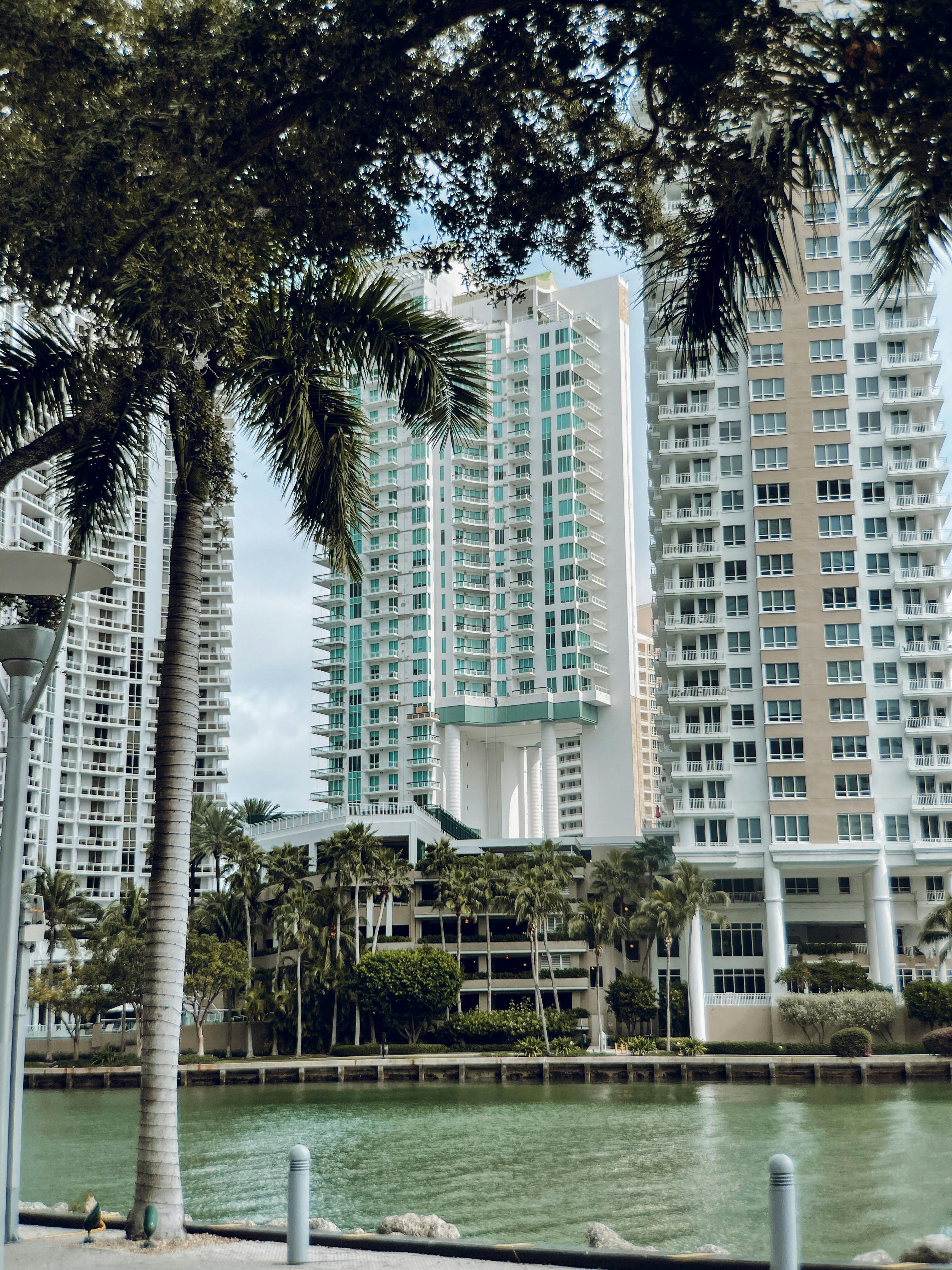 White Concrete High-rise Building Near Sea at Daytime · Free Stock Photo