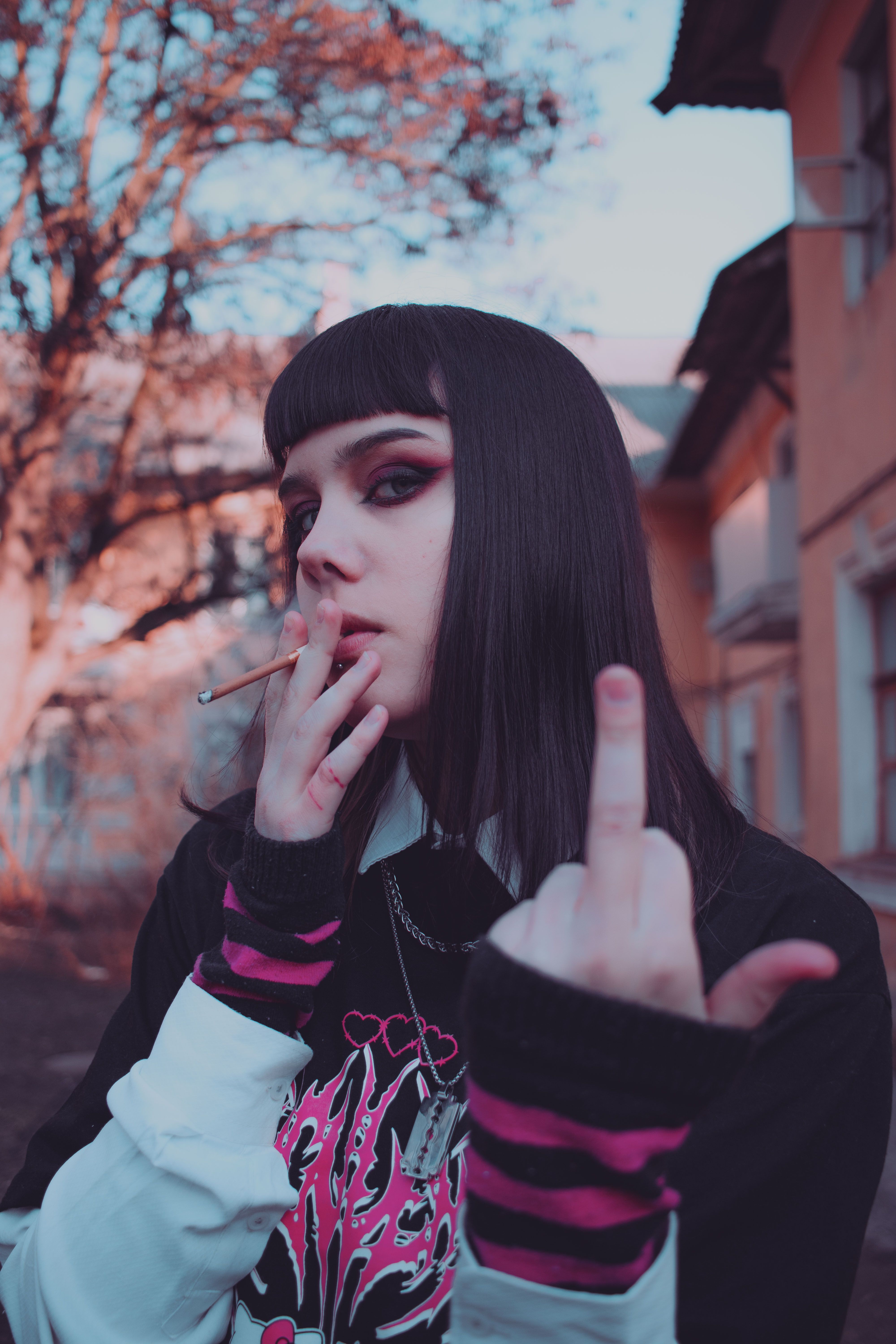 Person in Black Fur Jacket and a Mask Smoking a Cigarette · Free Stock ...