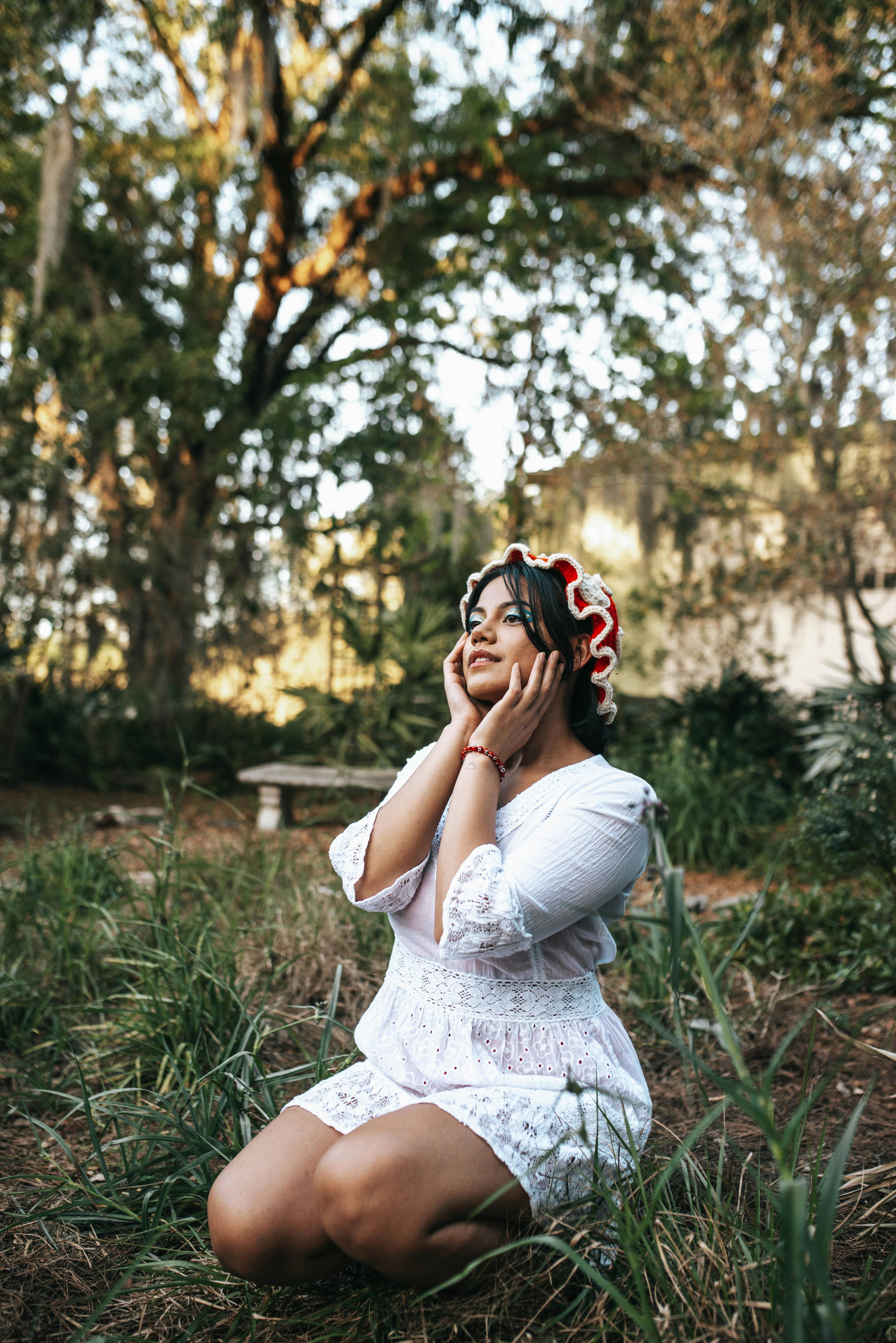 Woman Crouching near Tree · Free Stock Photo