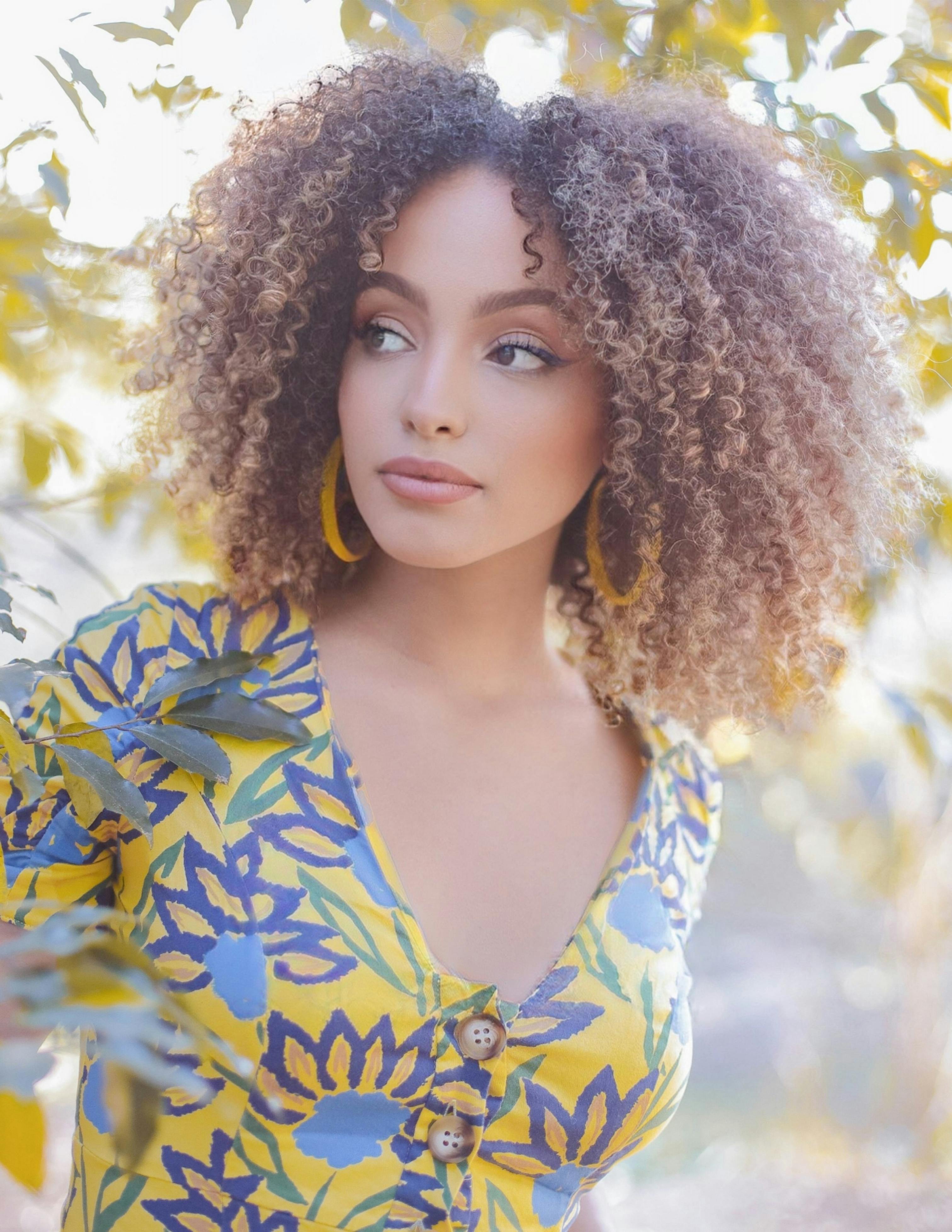Portrait of Woman with Curly Hair · Free Stock Photo