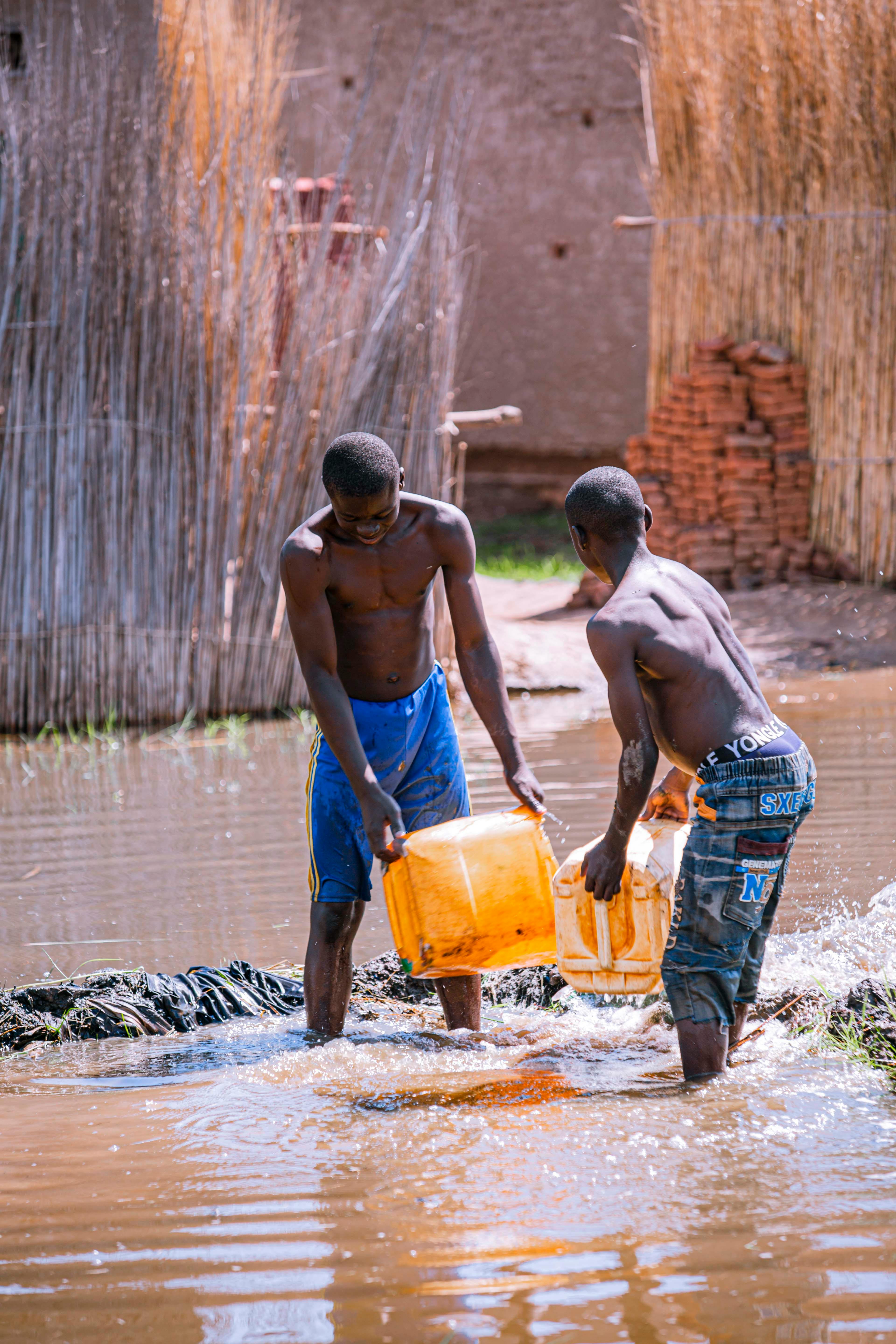 Kids Getting Water on the Pond Using Plastic Container · Free Stock Photo