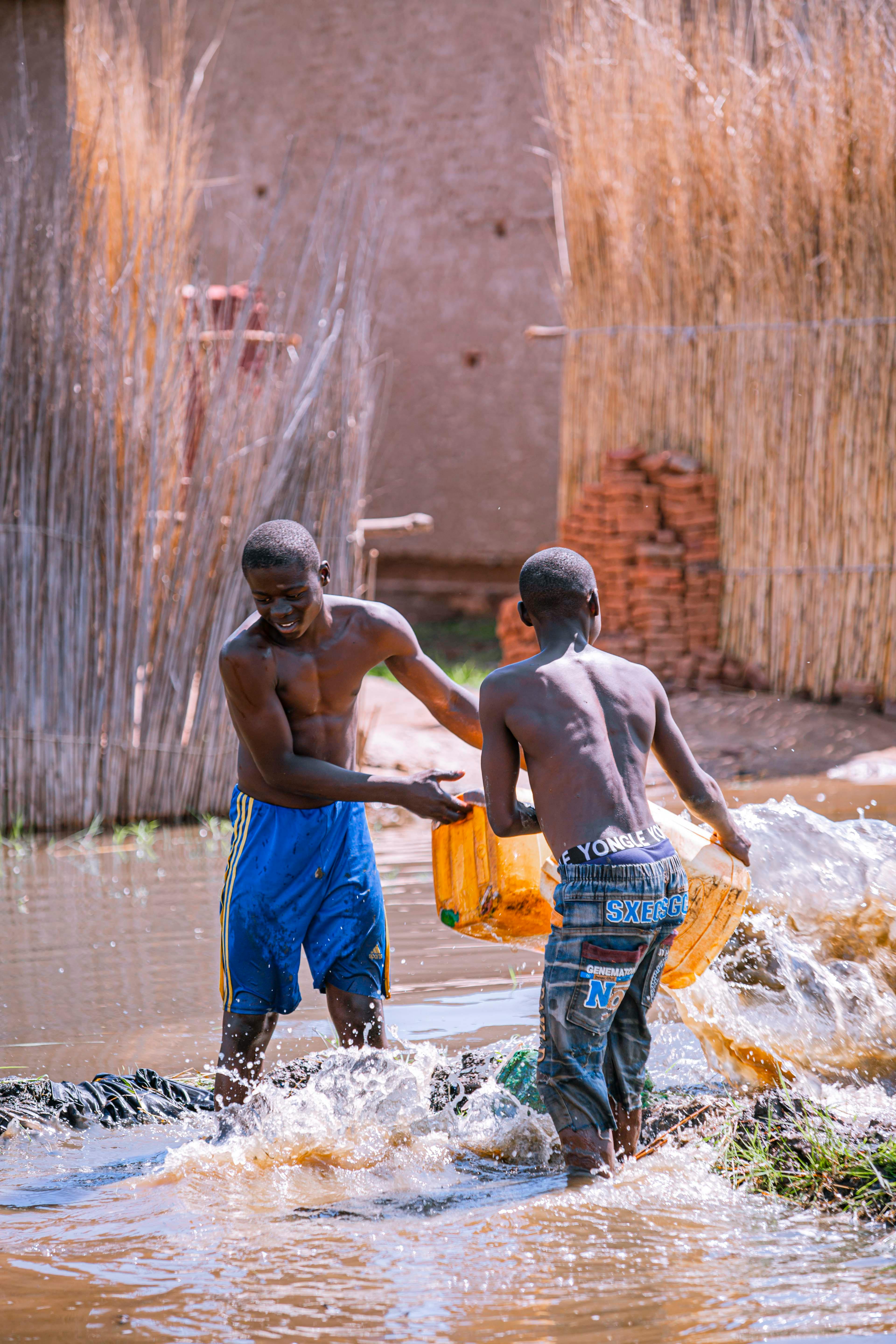 Kids Getting Water on the Pond Using Plastic Container · Free Stock Photo