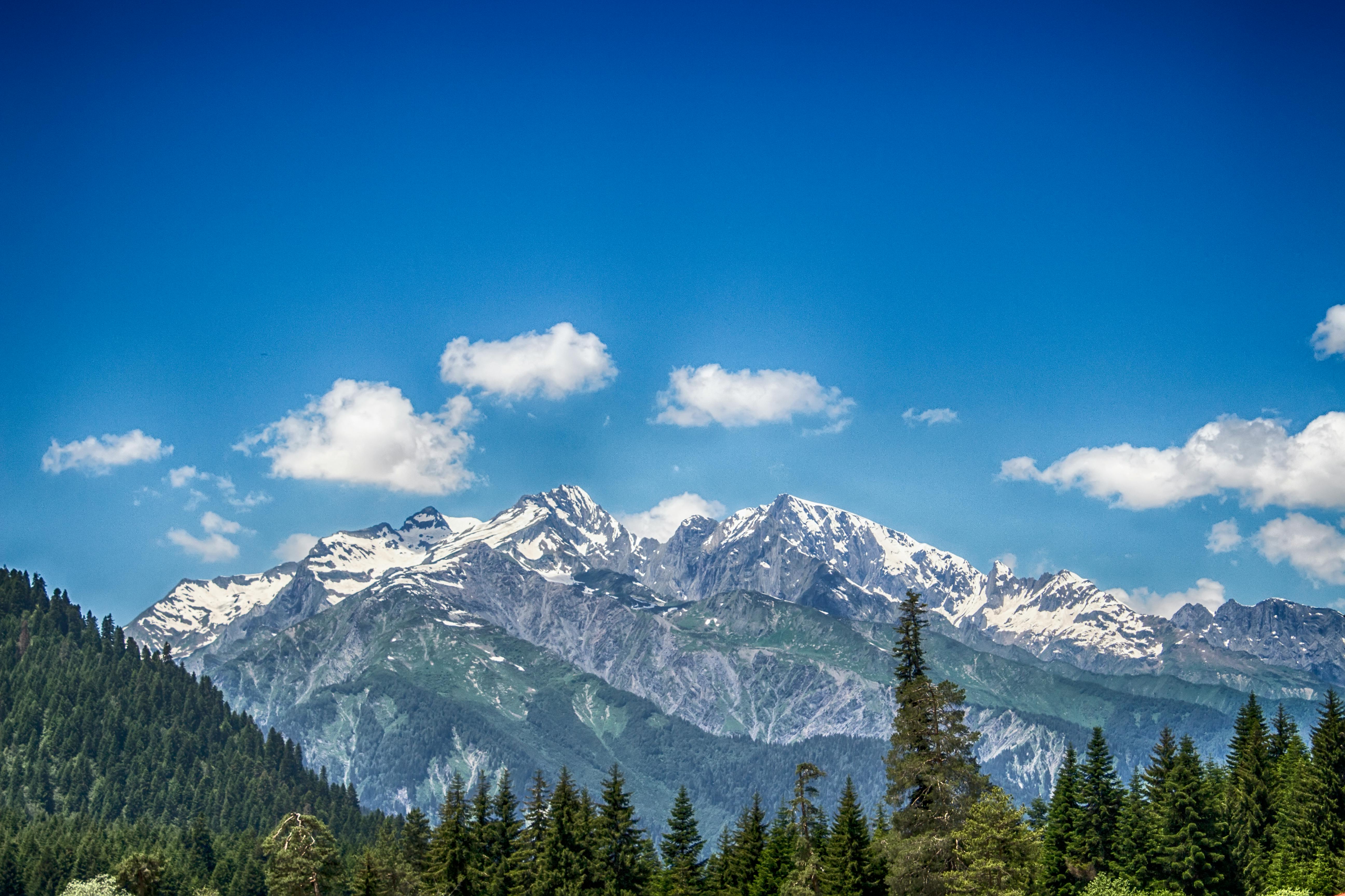 Green and White Snow-capped Mountain Under Blue Skies · Free Stock Photo