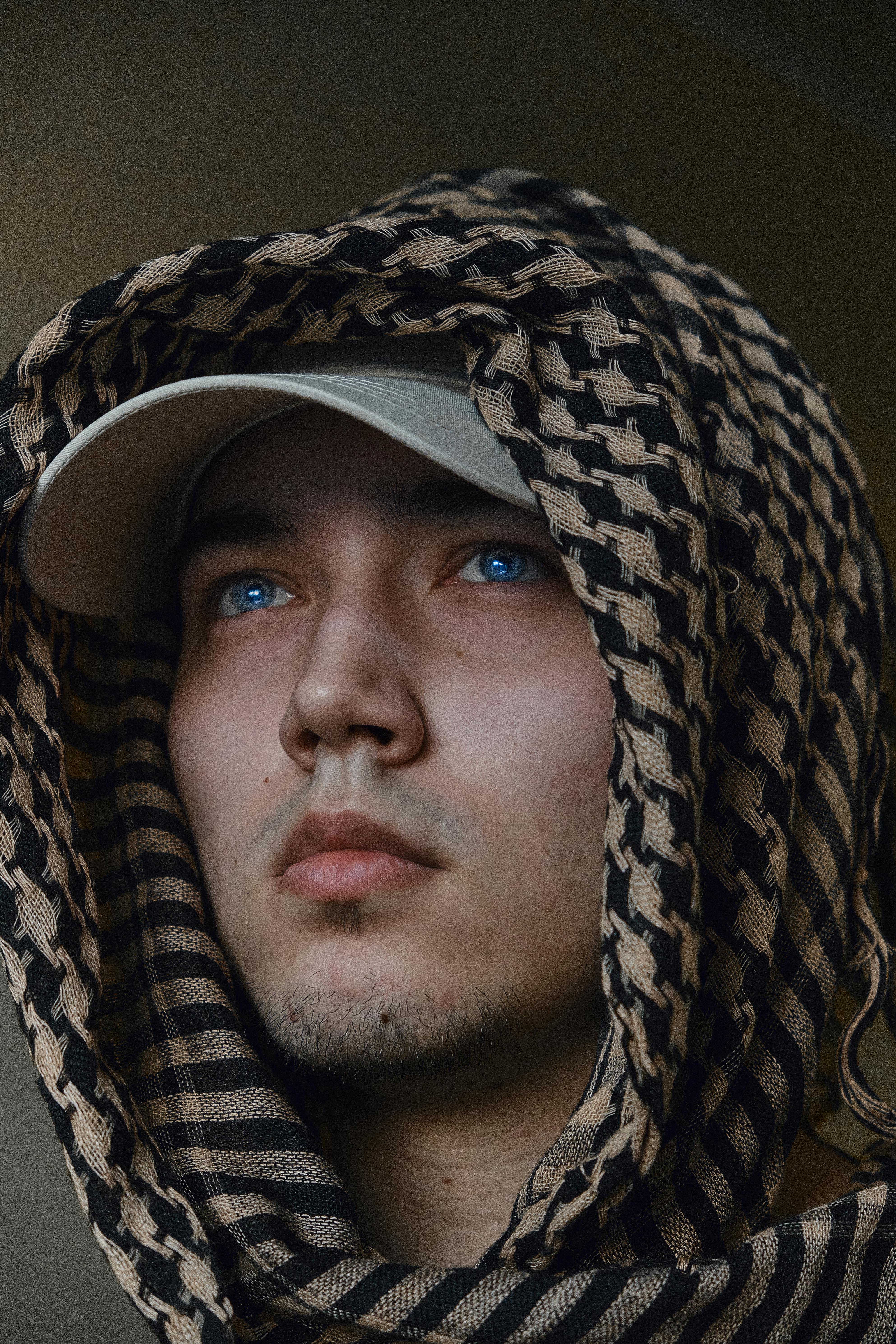 Photo of a Man with a Black Cap Looking Down · Free Stock Photo
