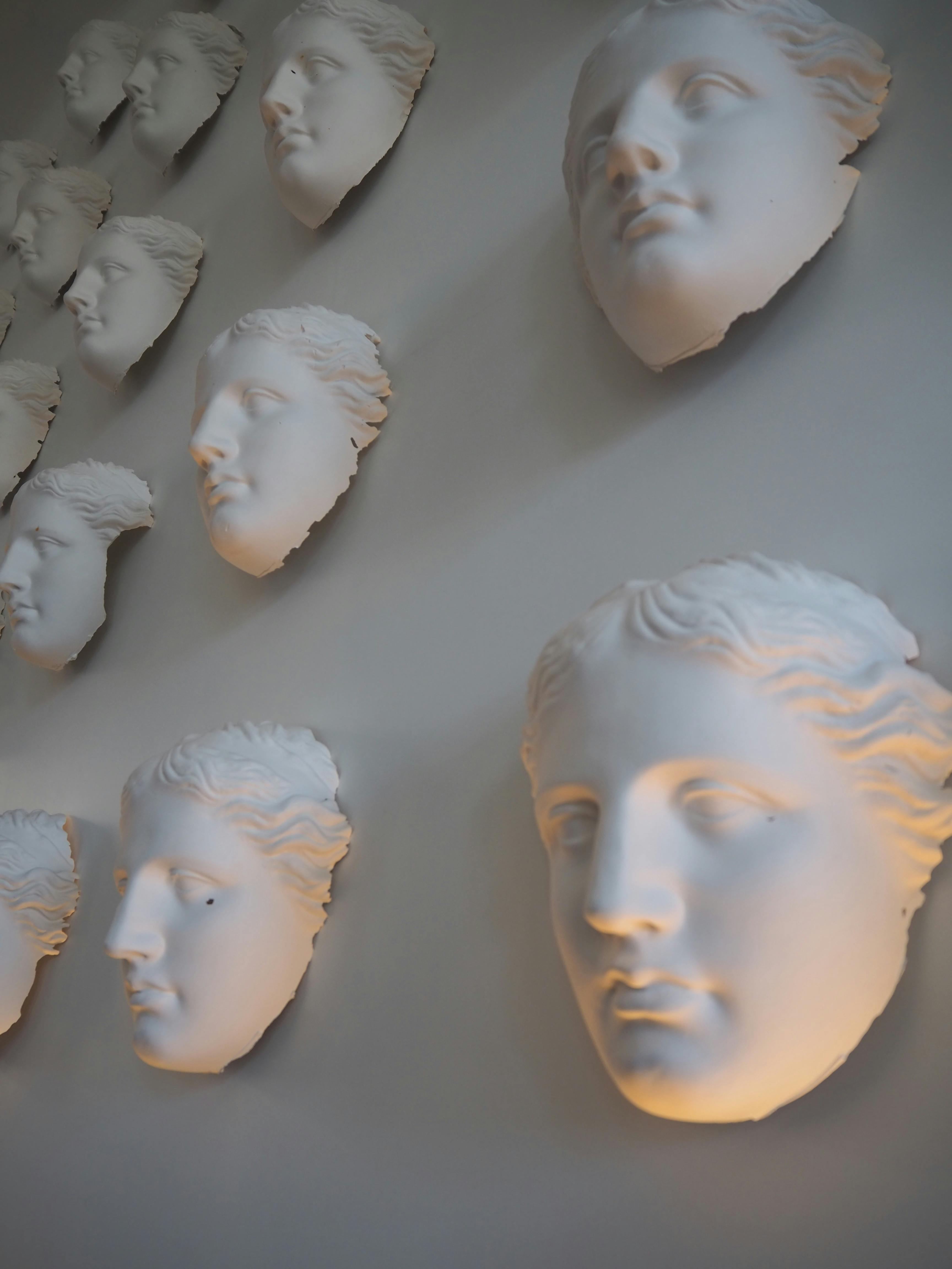 White Ceramic Face Figurine Hanging on White Wall · Free Stock Photo