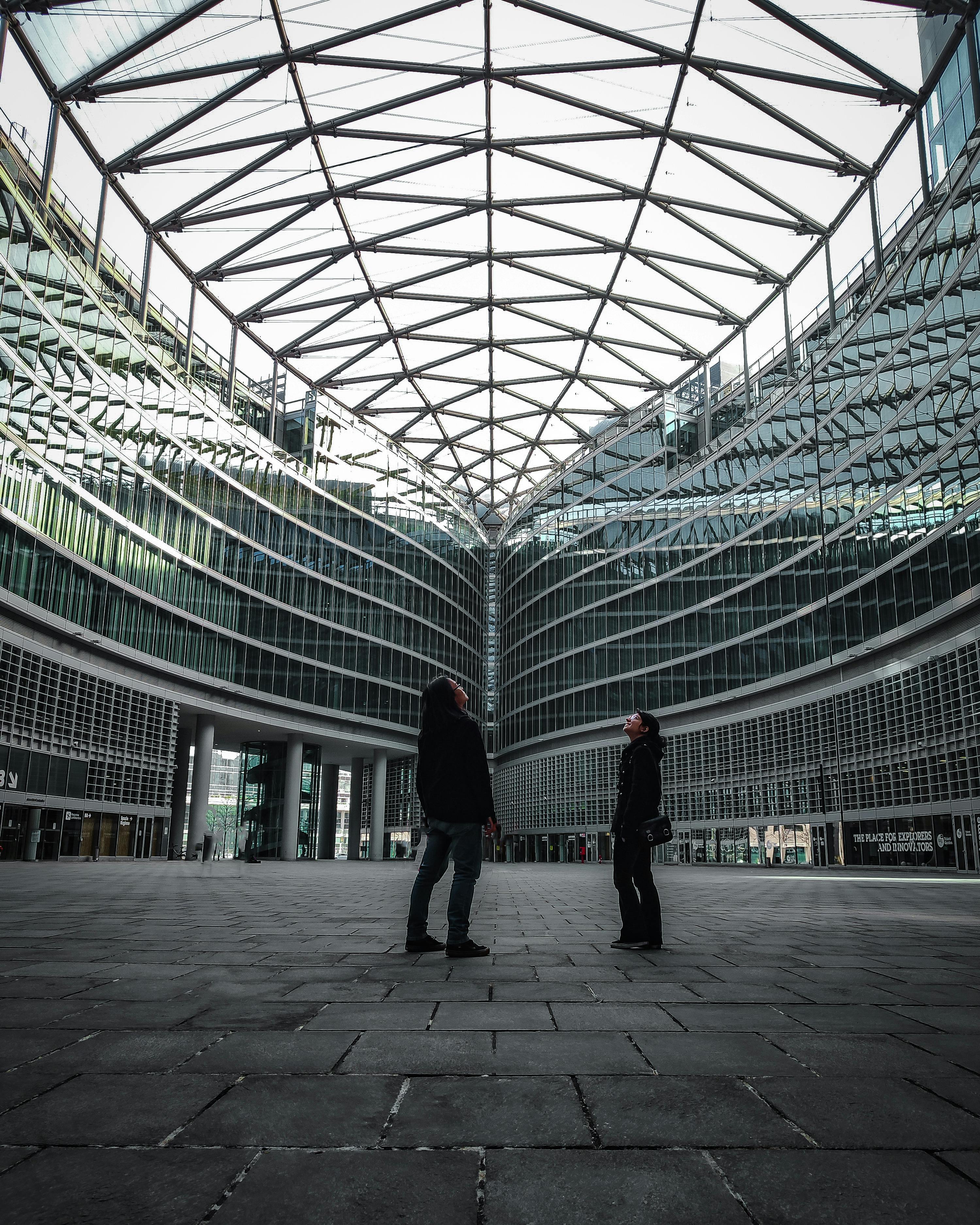 Photo of Man Walking Near Buildings · Free Stock Photo