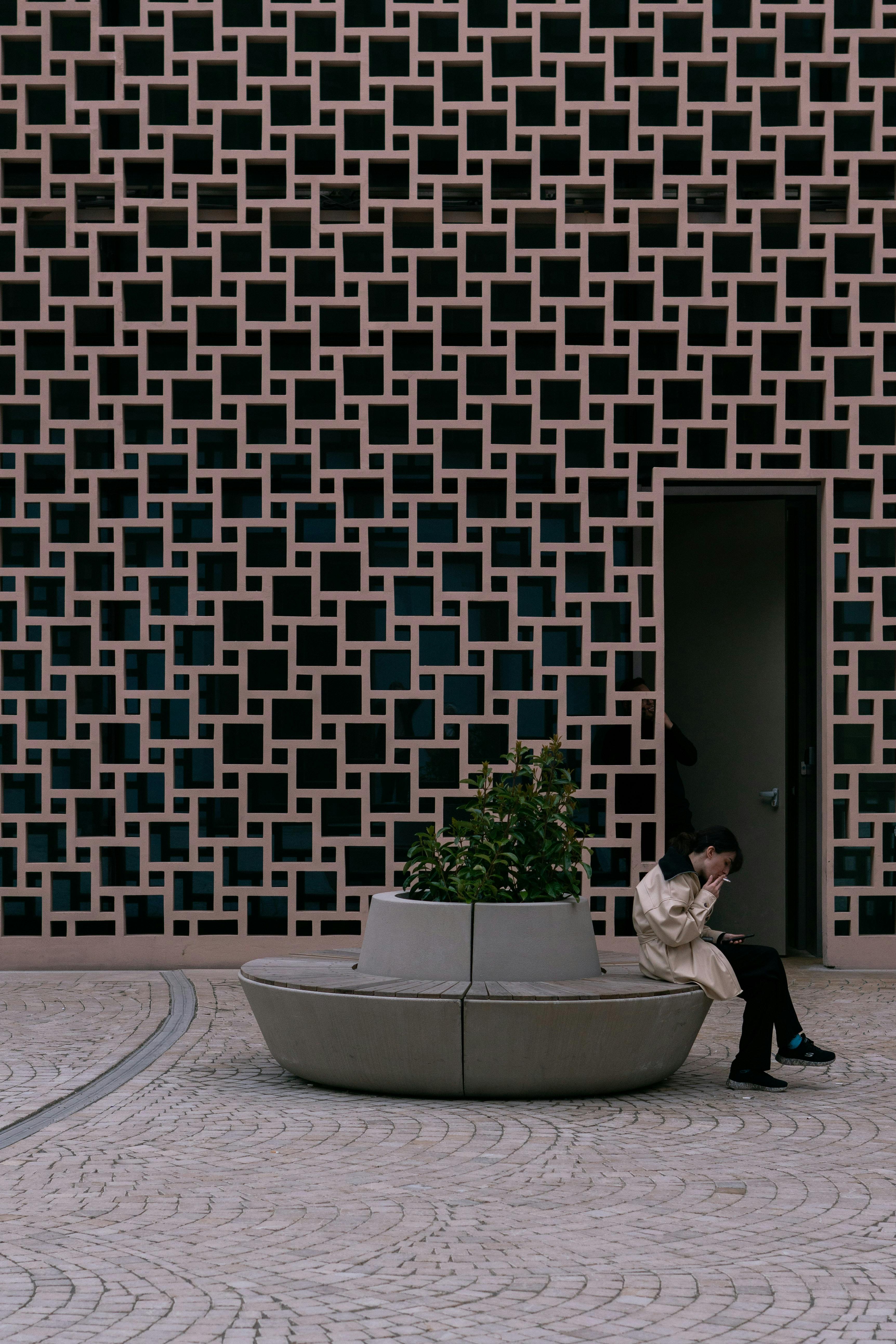 Woman Sitting on a Bench while Smoking · Free Stock Photo