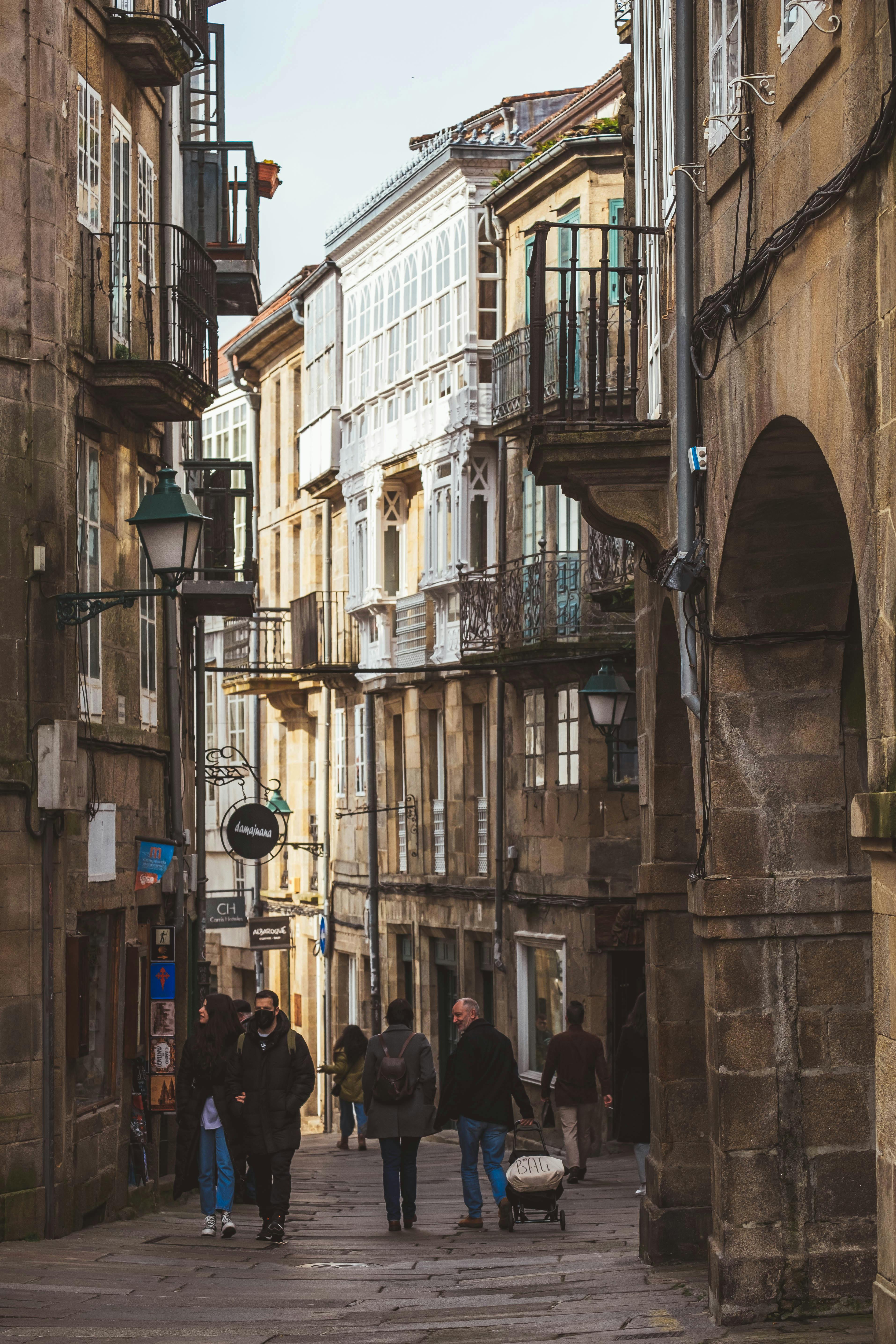 People Walking Between Buildings · Free Stock Photo