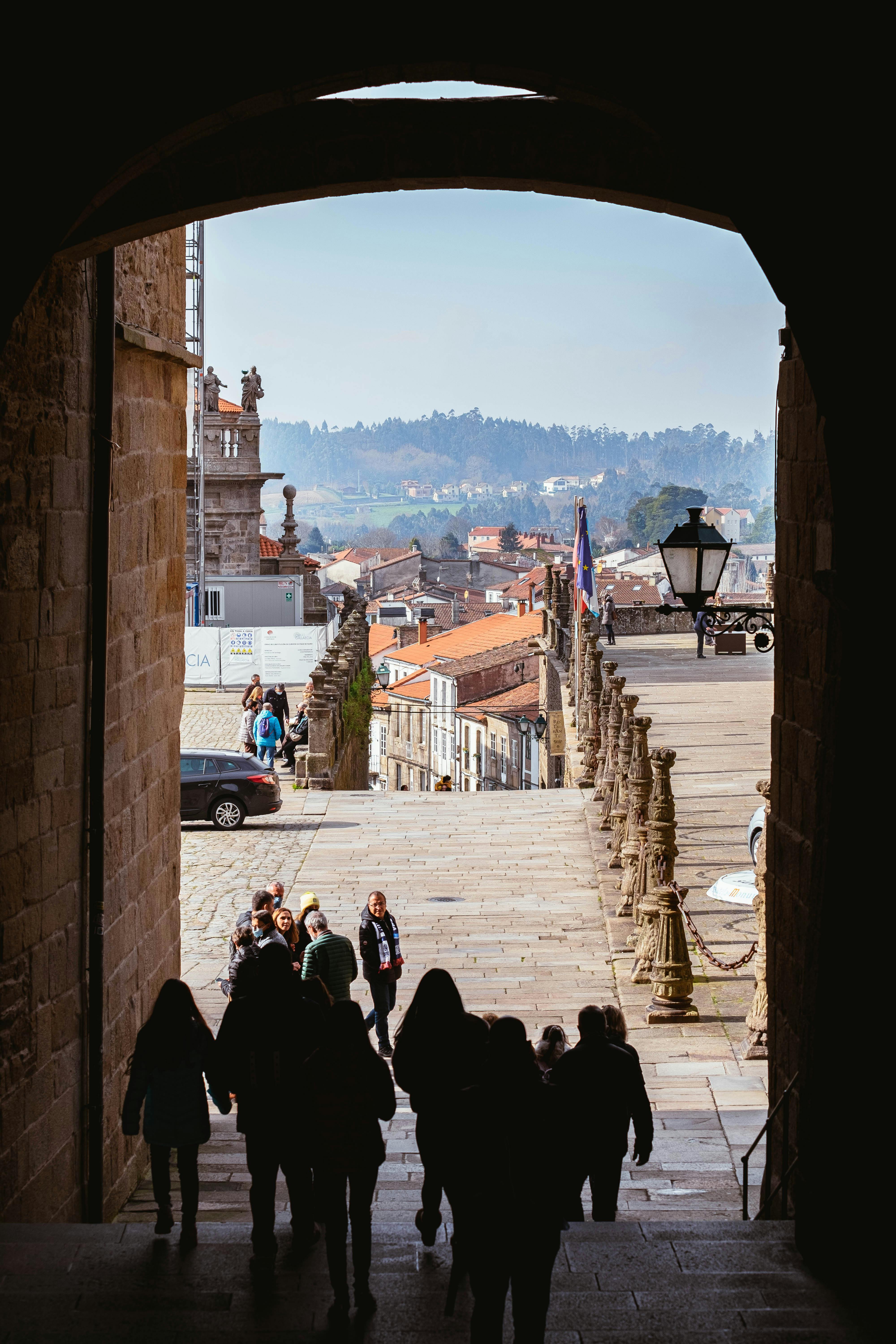 Silhouette of People Walking through Gate · Free Stock Photo