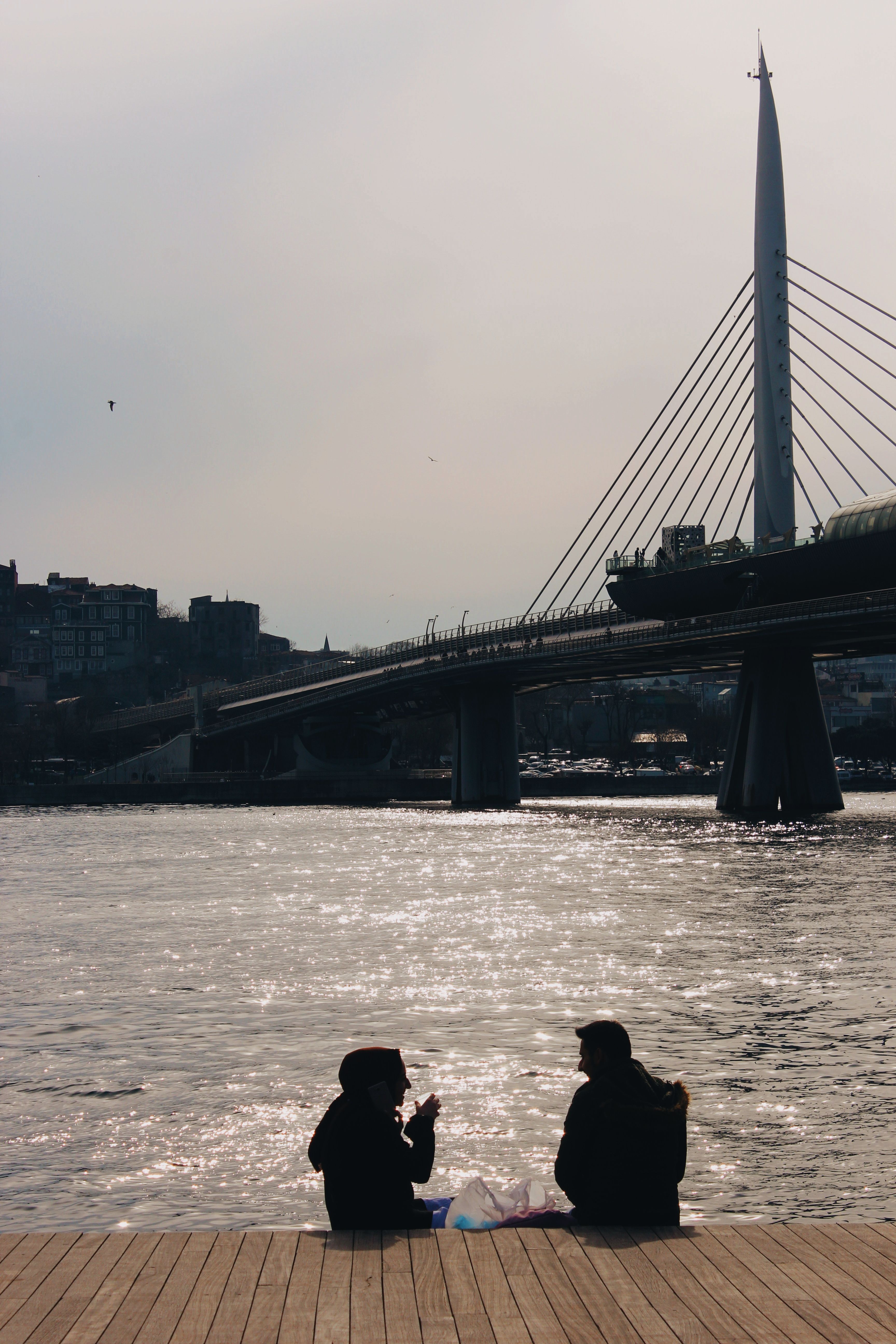 Two People Walking Along a Wooden Hanging Bridge · Free Stock Photo