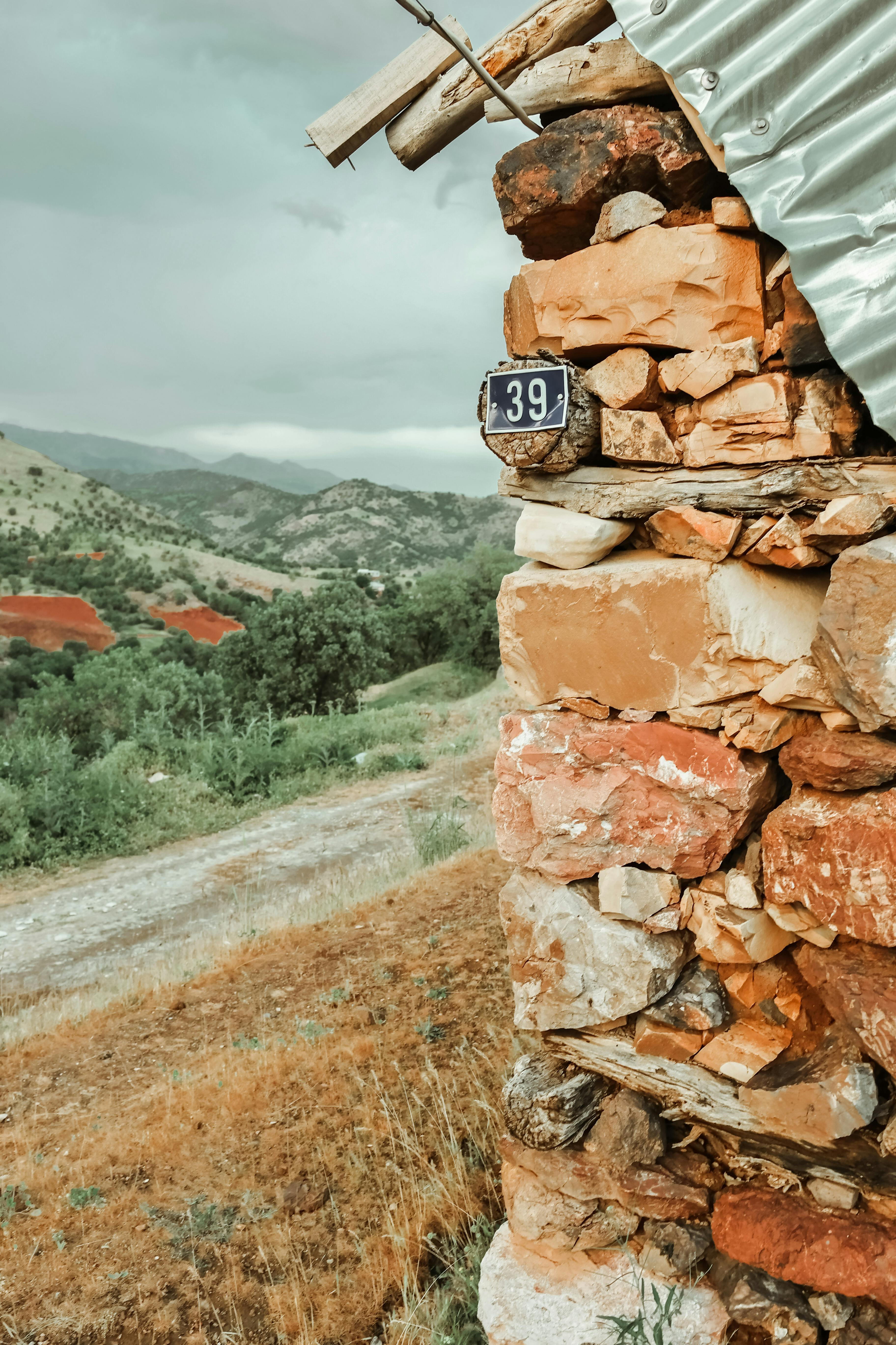 Stack of Rocks and Woods Near the Dirt Road · Free Stock Photo
