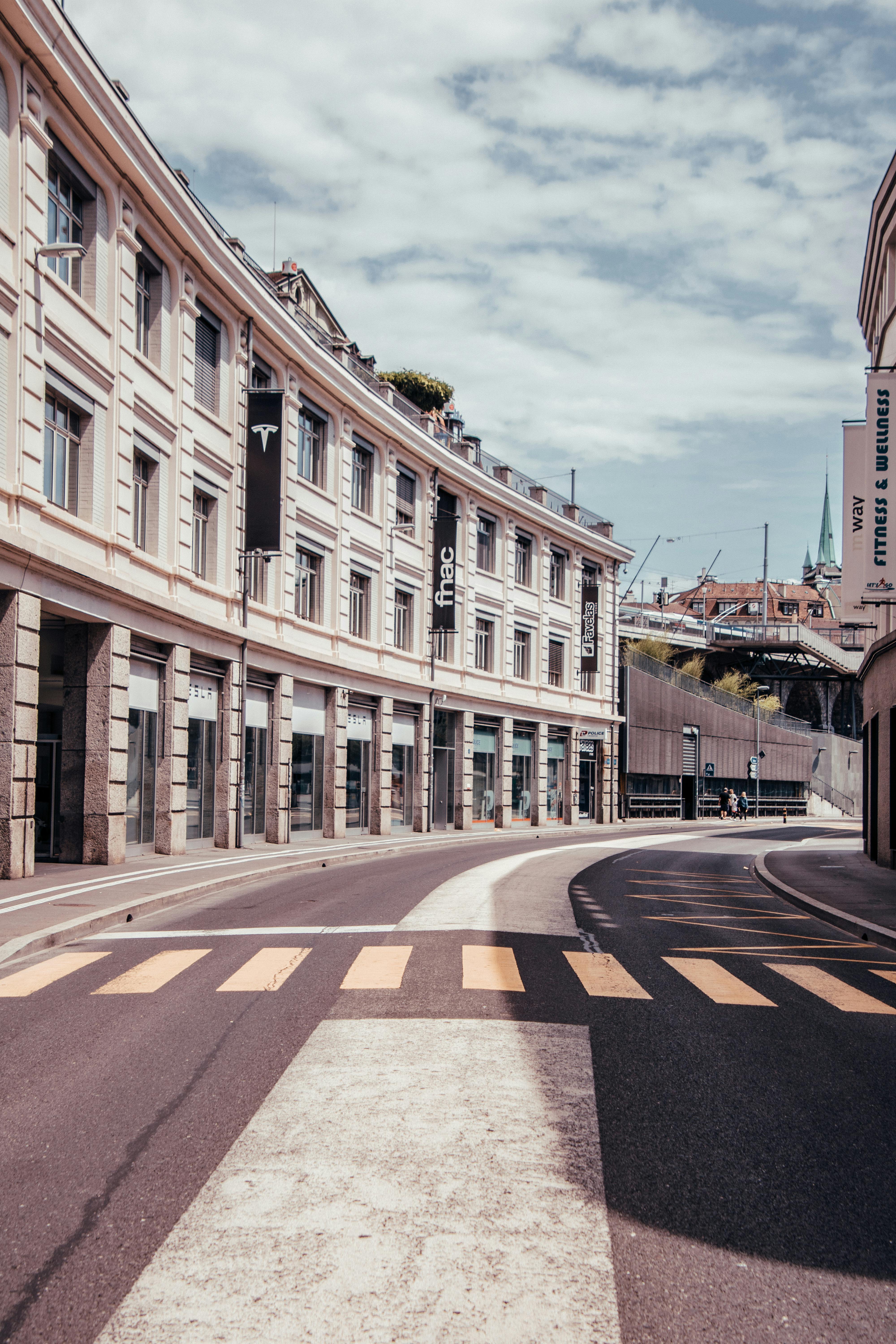 Cars on Road Near Concrete Building · Free Stock Photo