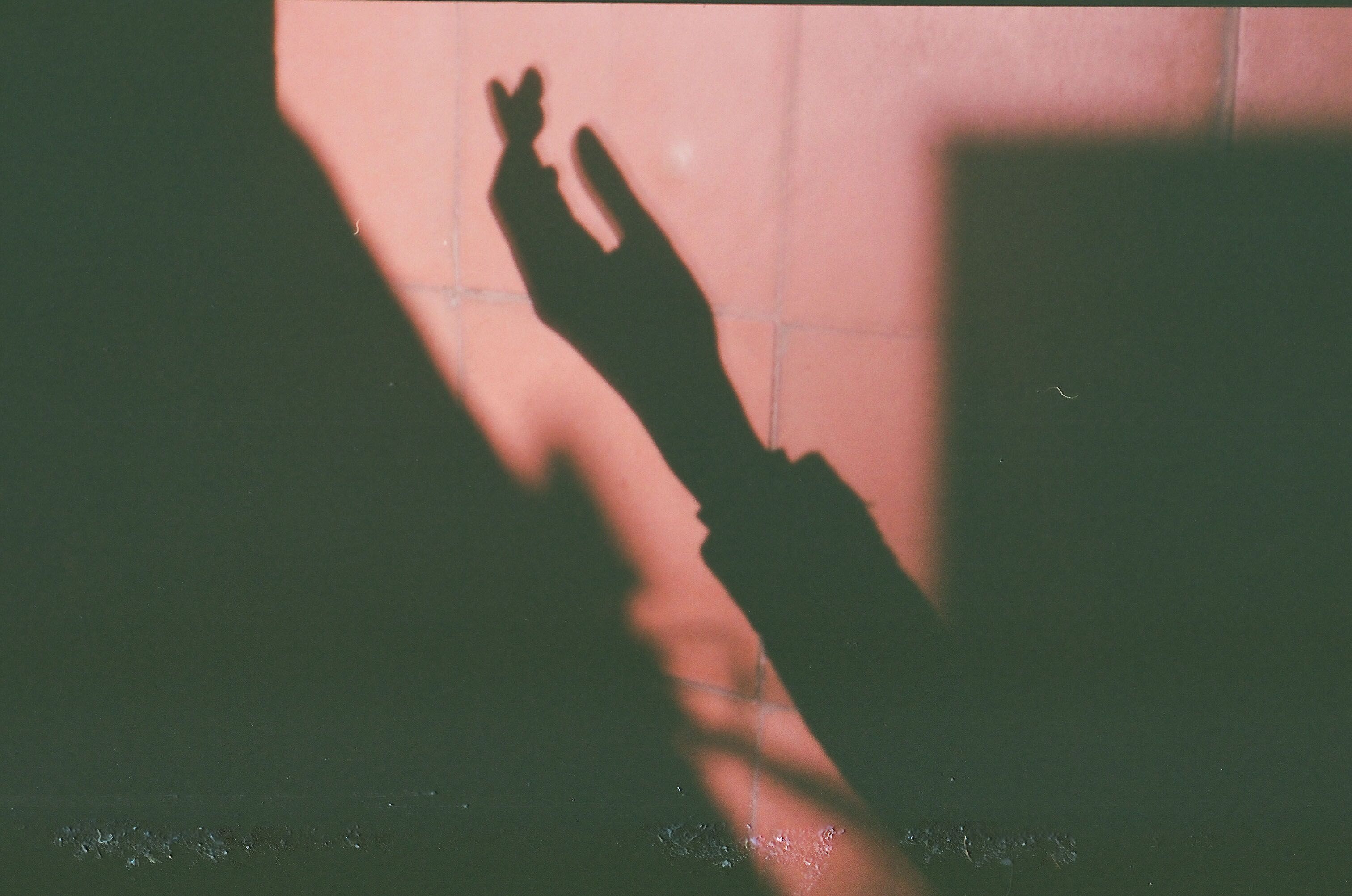 Shadow of Two People Almost Touching Hands · Free Stock Photo