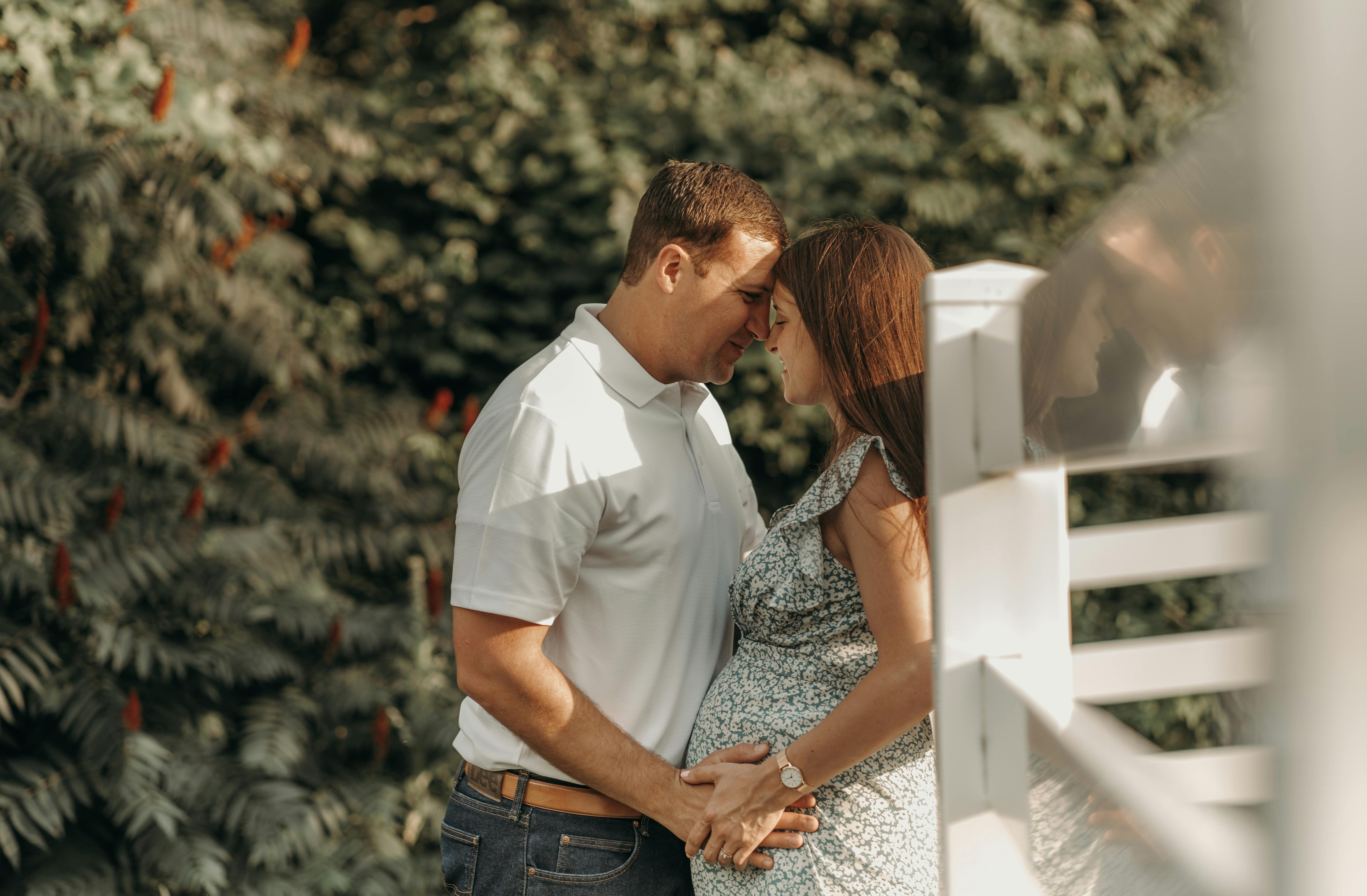 A Man Touching His Wife Baby Bump · Free Stock Photo