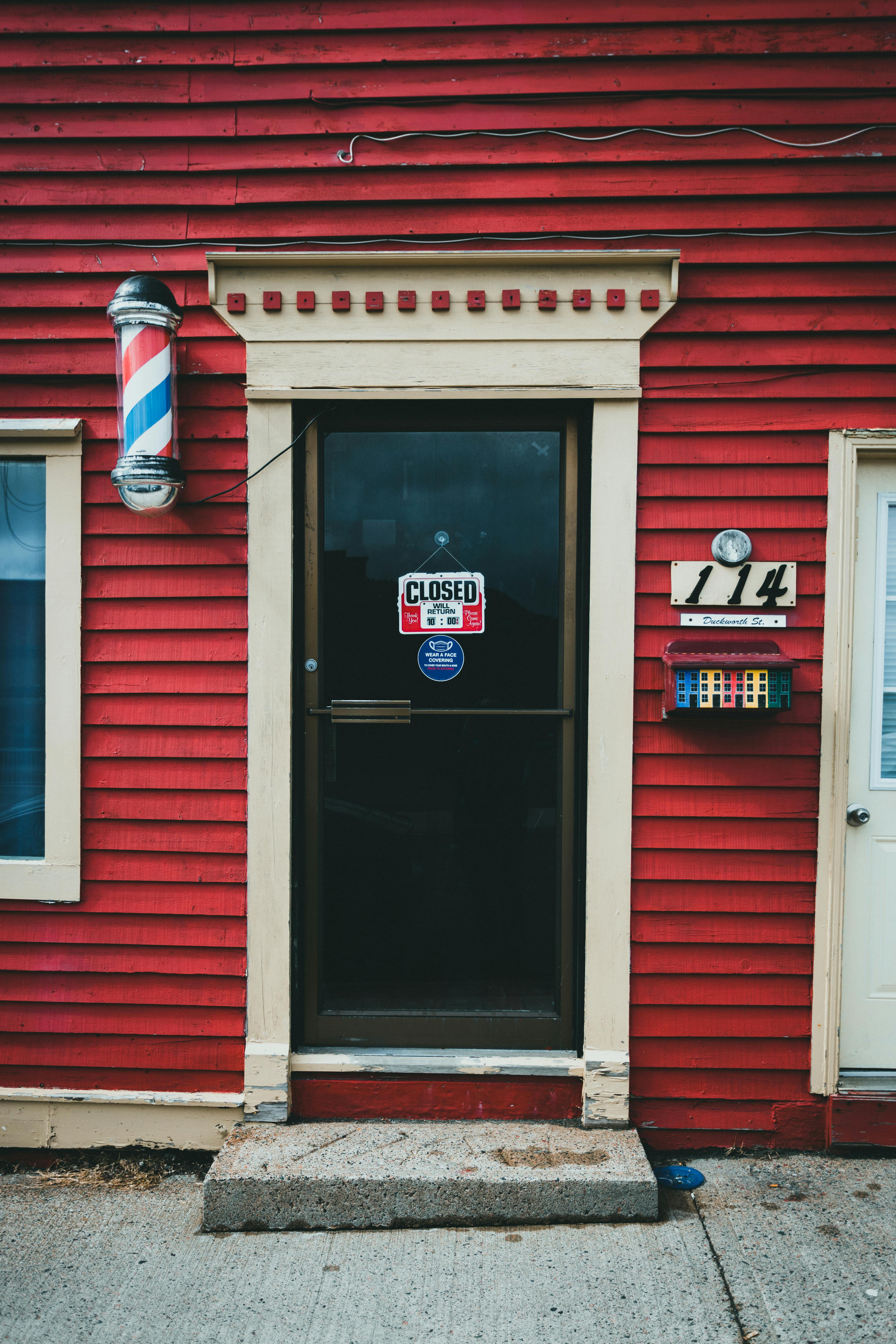 Entrance to a Barbershop in a Red Building · Free Stock Photo
