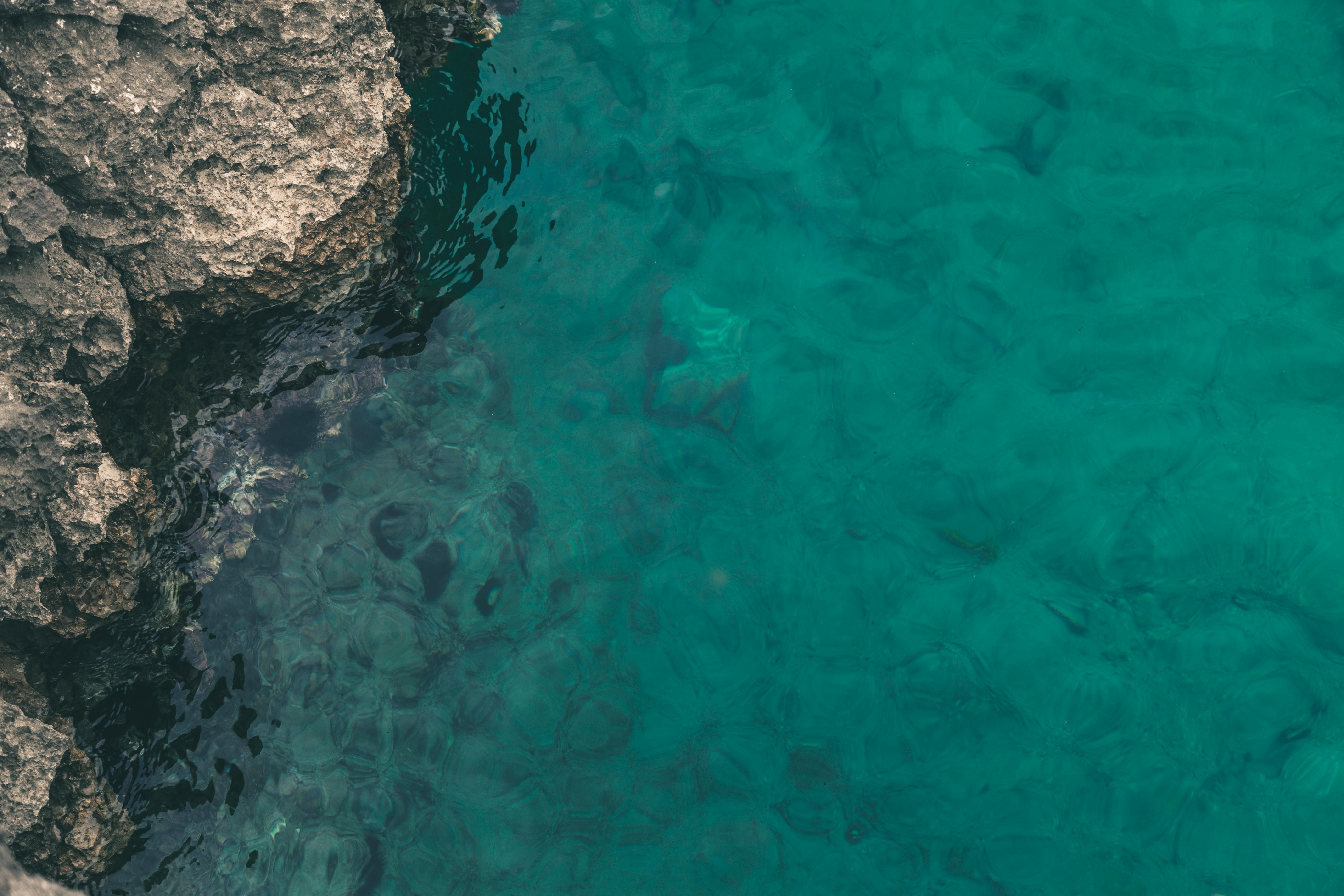 Ocean Beside Stone · Free Stock Photo