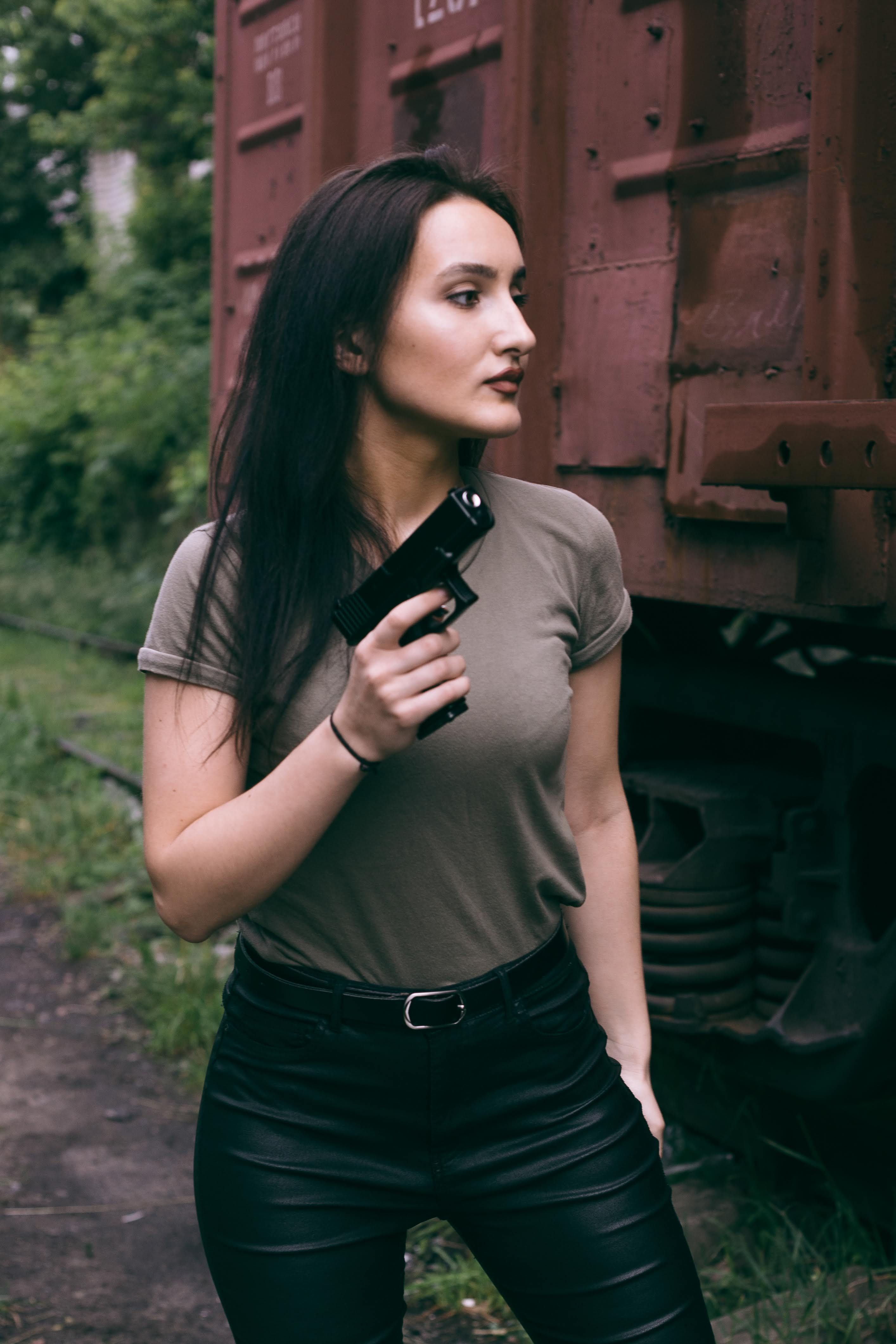 Woman Holding a Bullet · Free Stock Photo