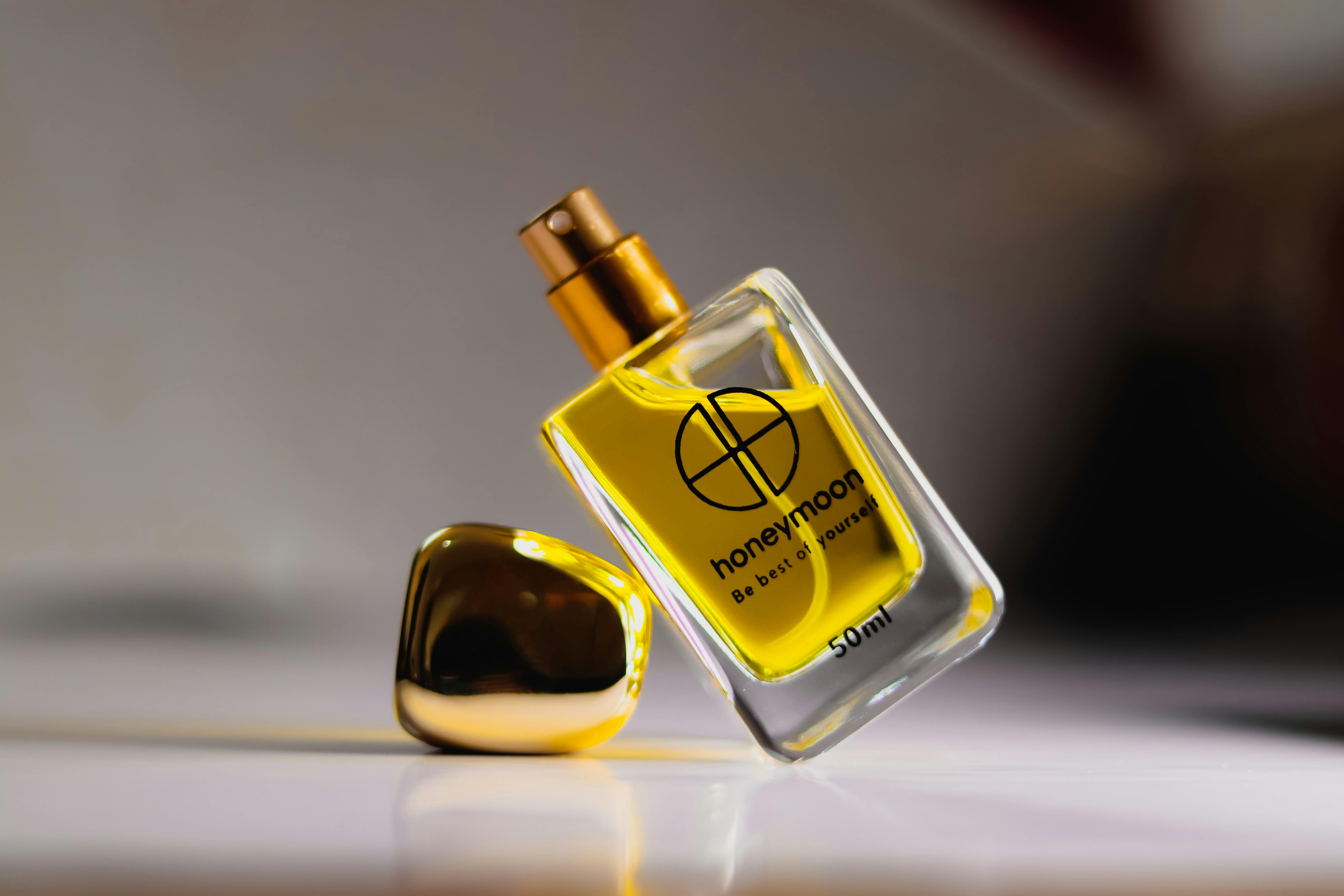 Golden Liquid in Perfume Bottle · Free Stock Photo