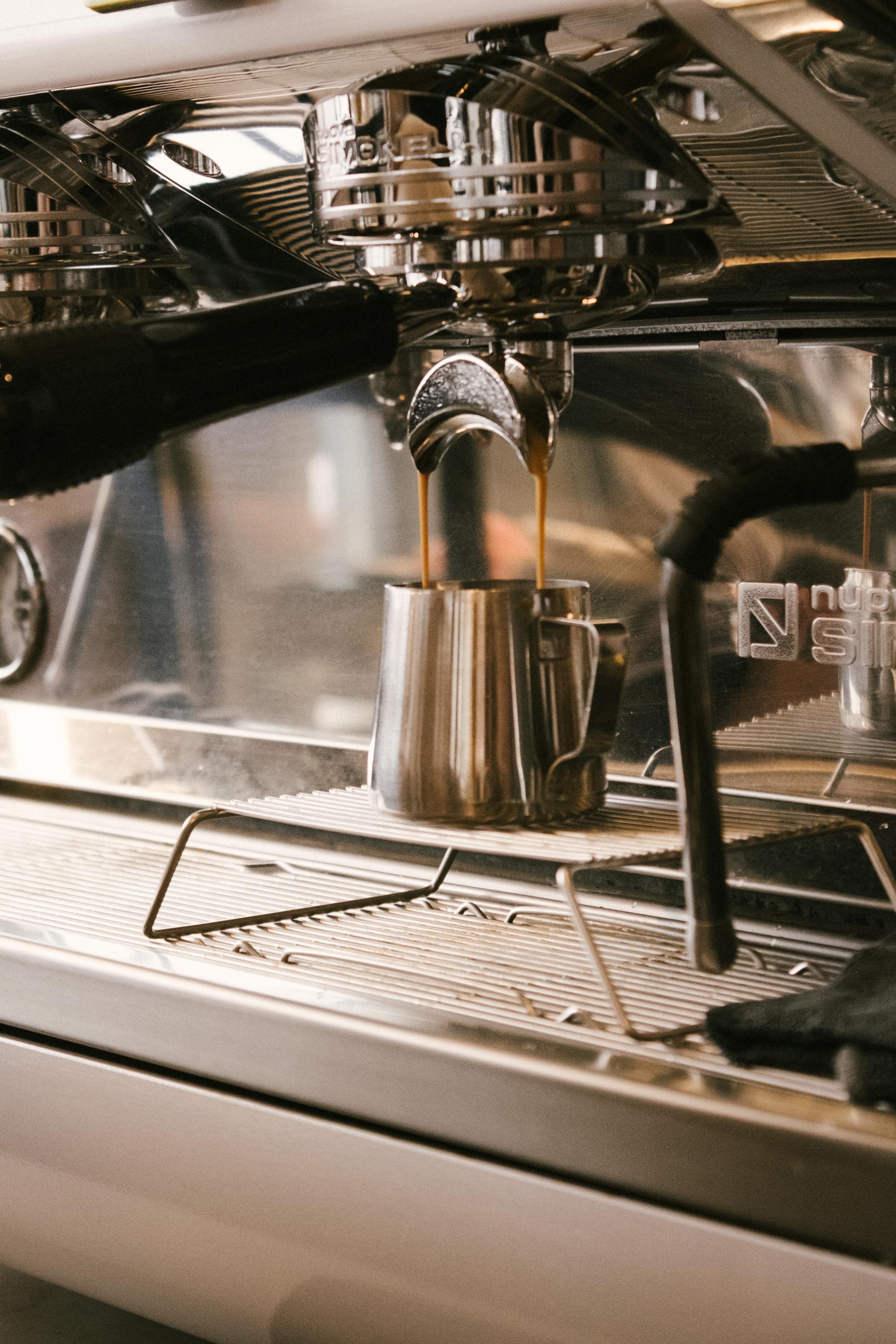 Portafilter against Coffee Machine · Free Stock Photo