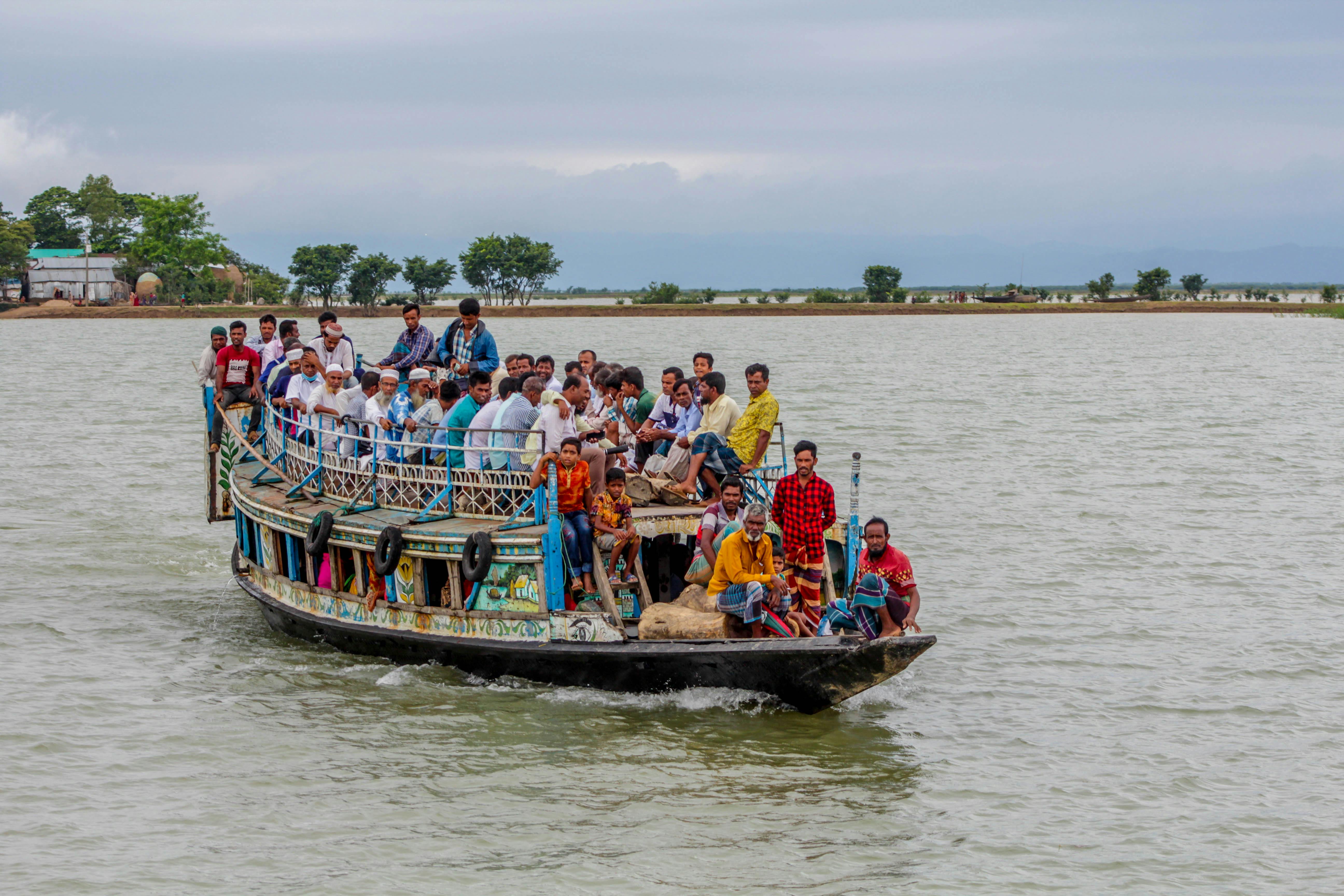 People Riding a Boat on Body of Water · Free Stock Photo
